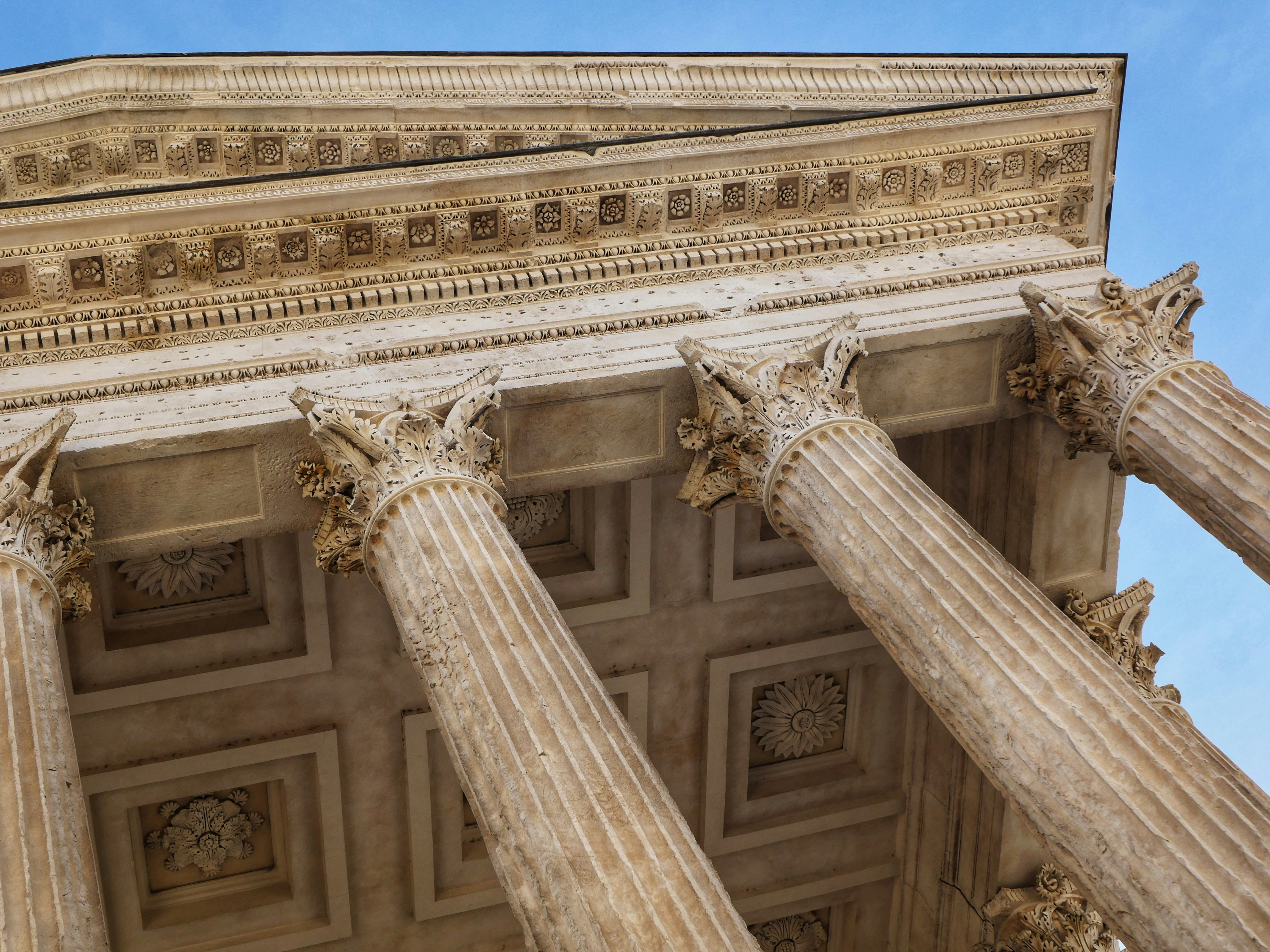 Stone Giants Under a Blue Sky: A Low-Angle Study of Corinthian Columns