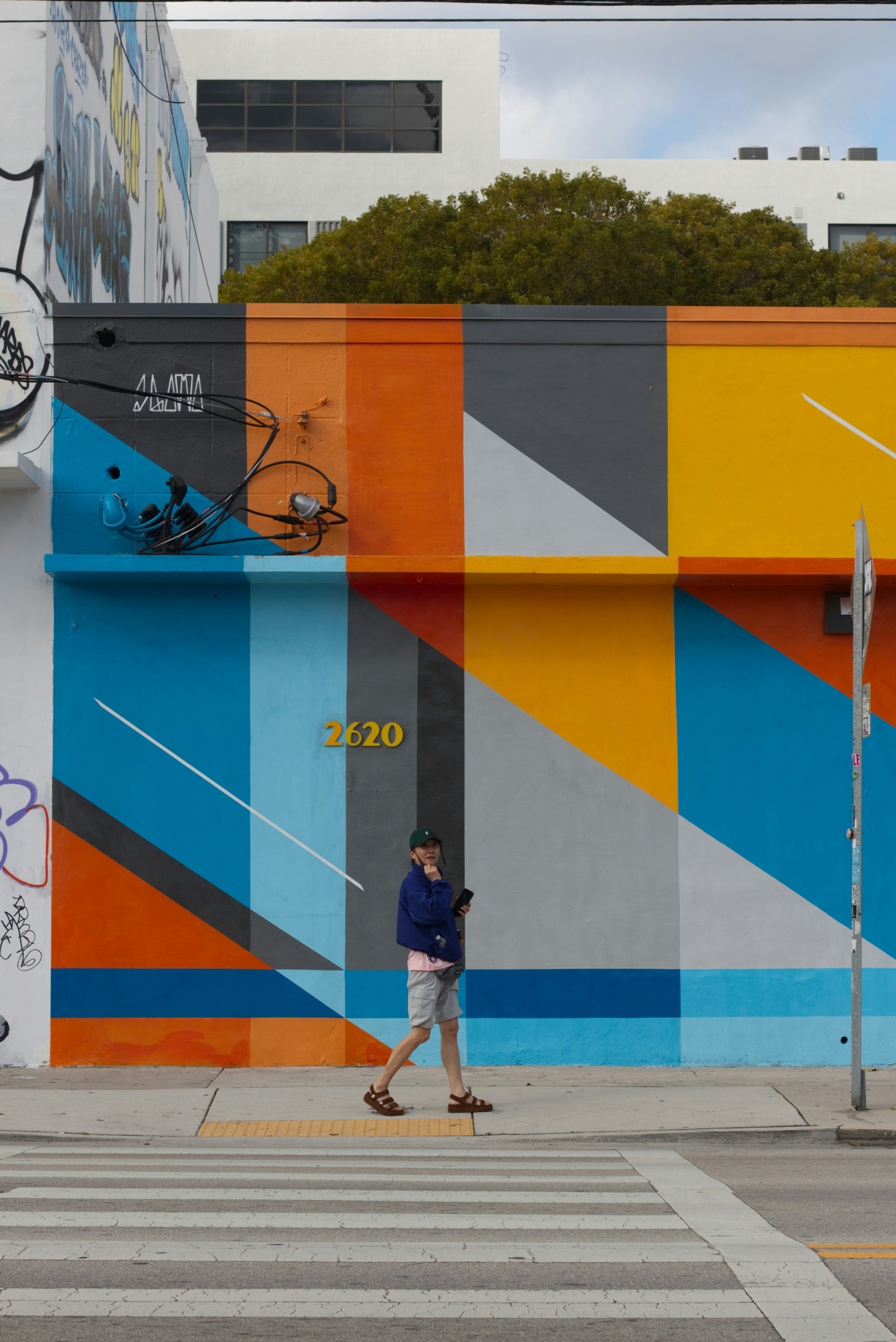 Crosswalk Traveler in Front of Geometric Wall