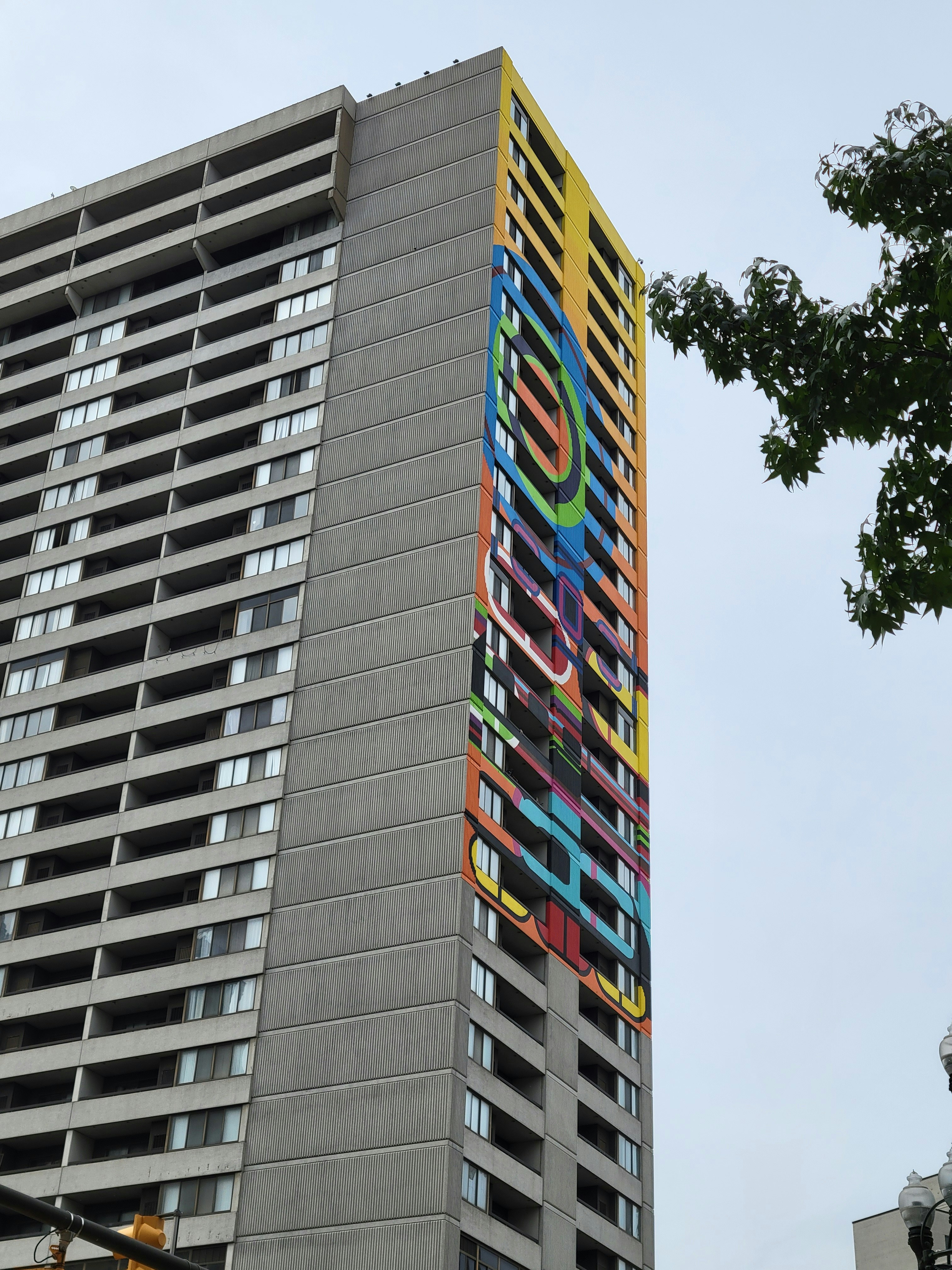Chromatic Skyline: A Rainbow Banner Clad Tower Reaches for the Sky