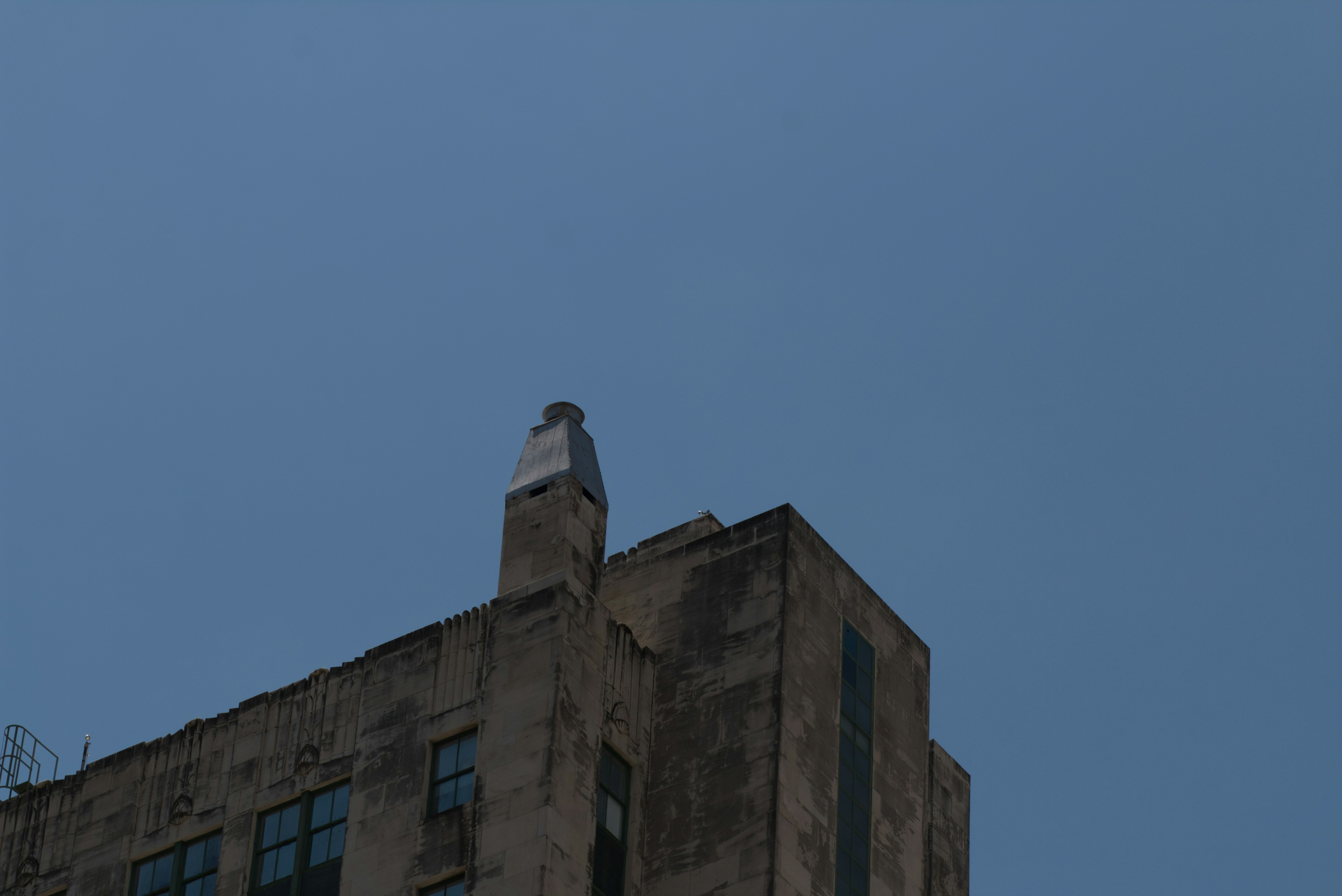 Corner Chimney Against Clear Blue: A City Block Silhouette