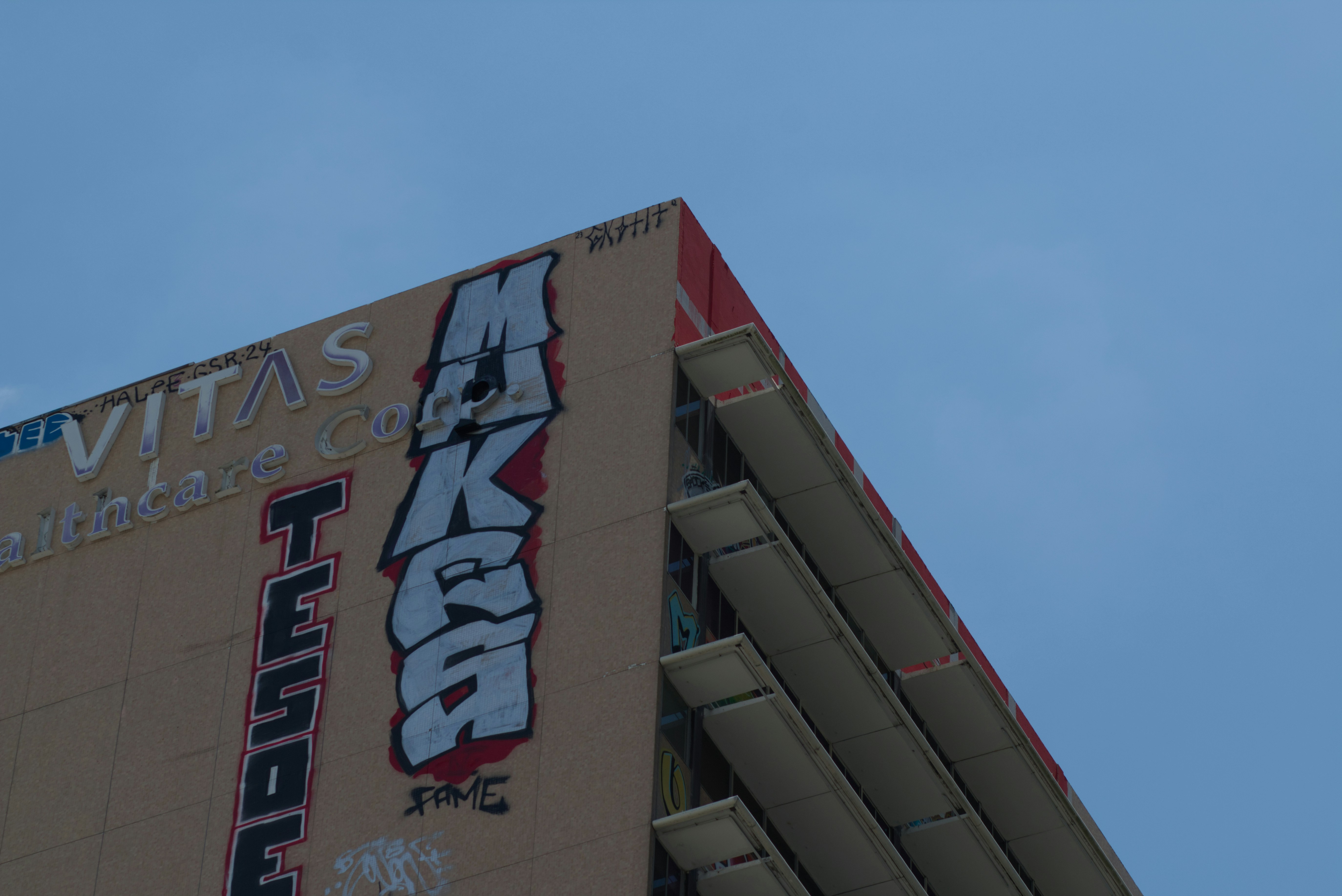 Neon Vertical Farewell: The Corner of a Daring Signage Facade