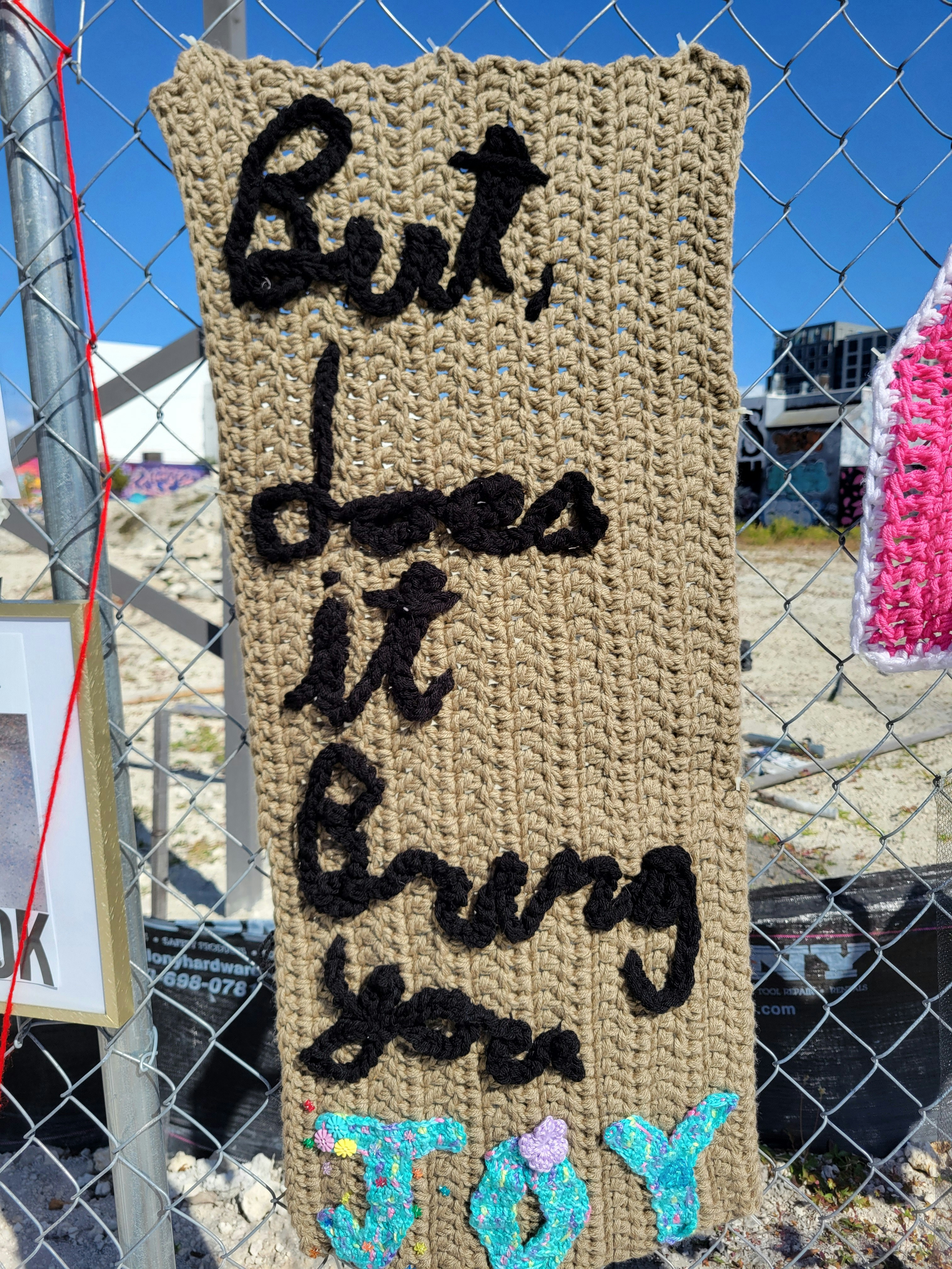 Handwoven Message Board: 'But close it wrong you' emerges on a sunlit fence