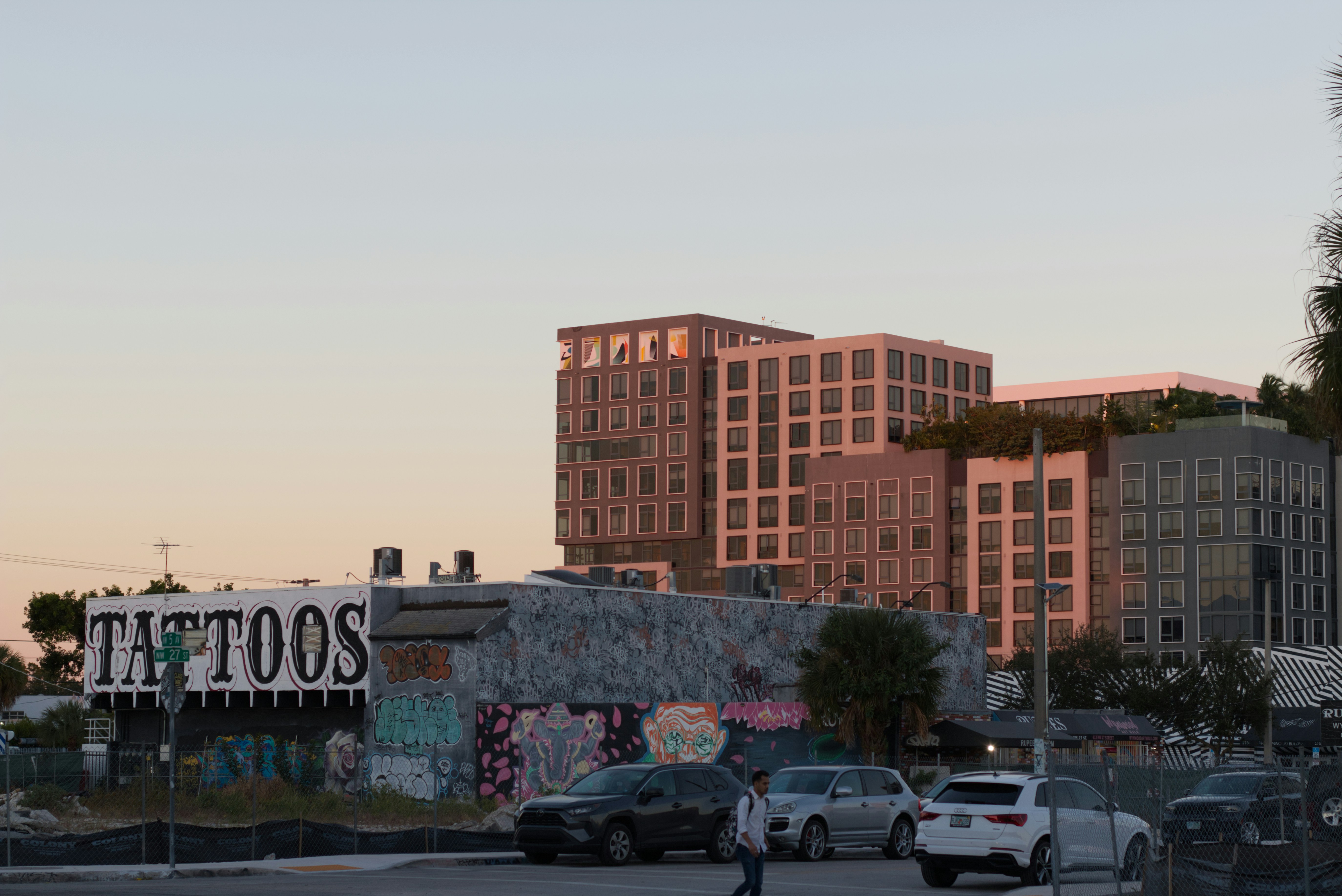 Urban Edge: Sunset Light Over the Tattoo Parlor and Modern Blocks