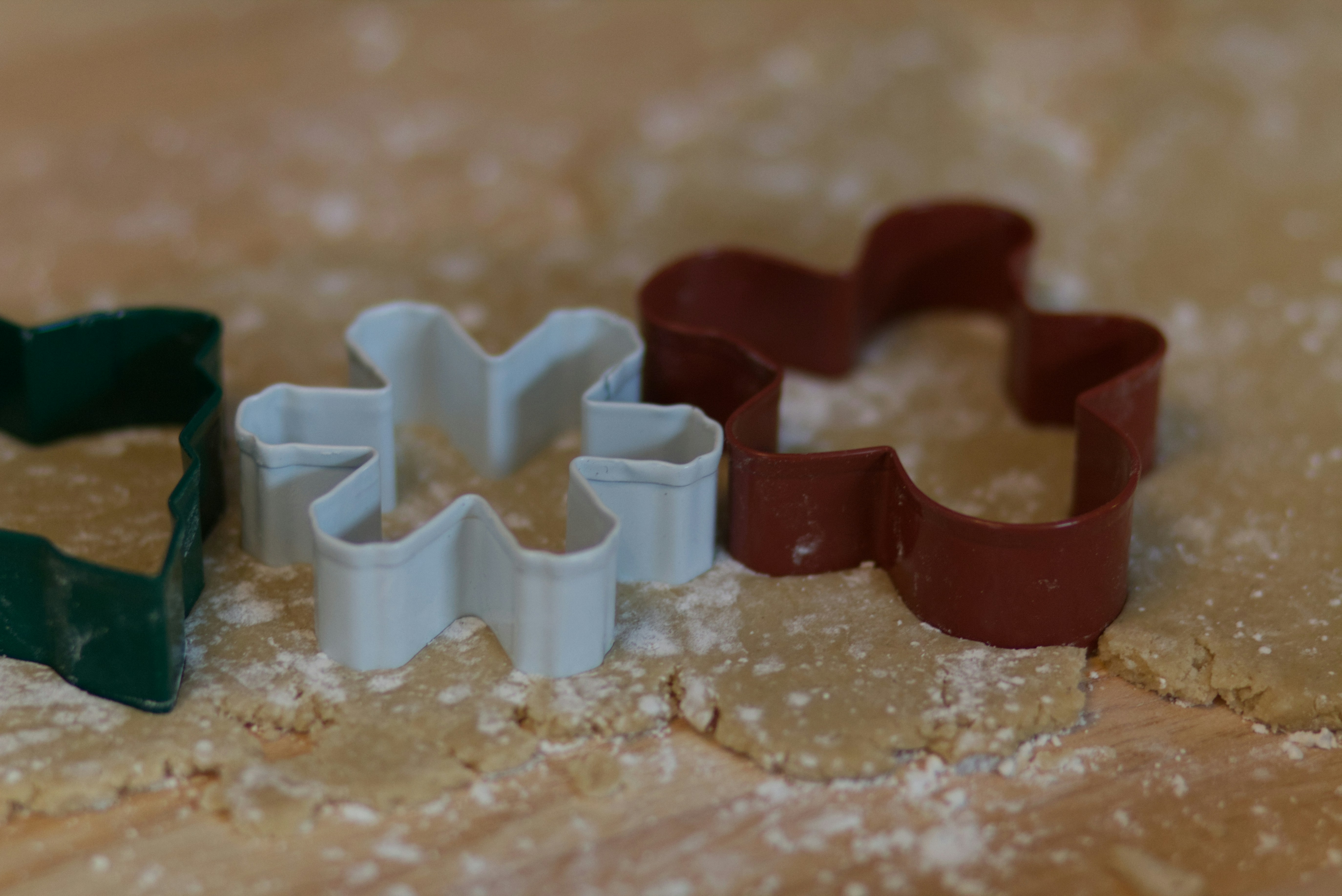Cookie Cutters in Focus: Star and Heart Shapes Resting on Dusty Dough