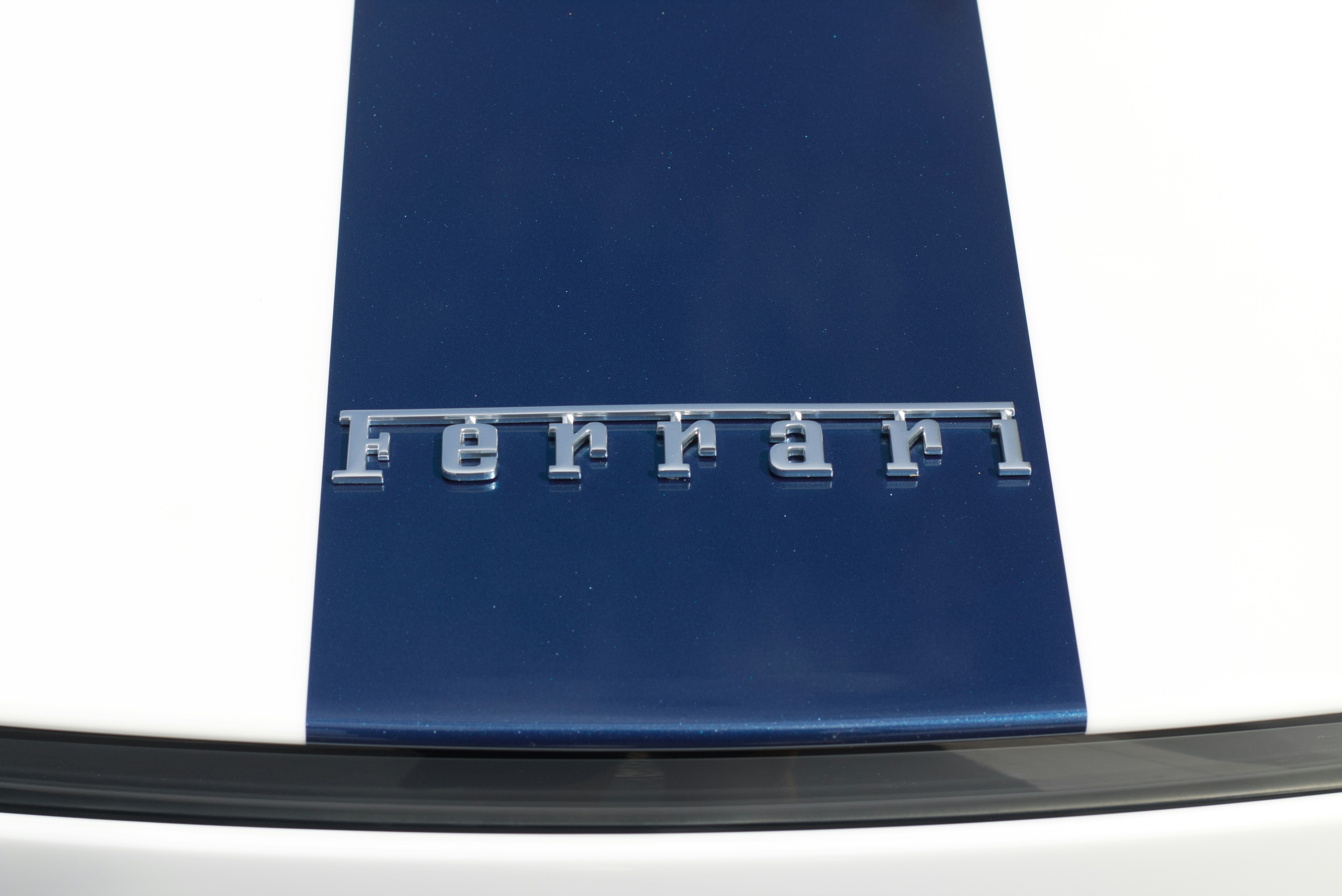 Blue Stripe Reveal: Ferrari Emblem on a Car’s Hood
