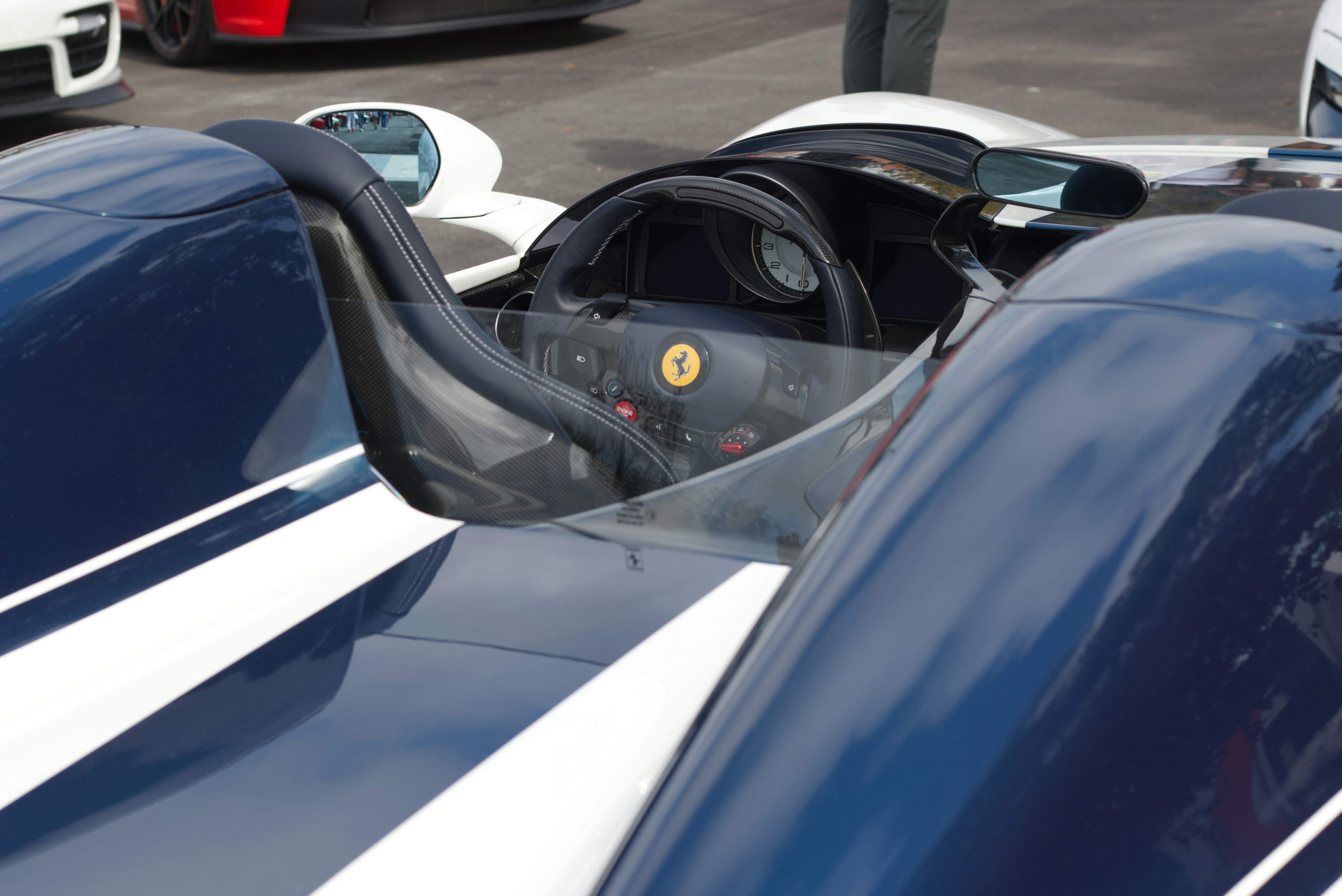 Spooled cockpit: a gleaming Ferrari roadster’s cockpit viewed through its sculpted bodywork