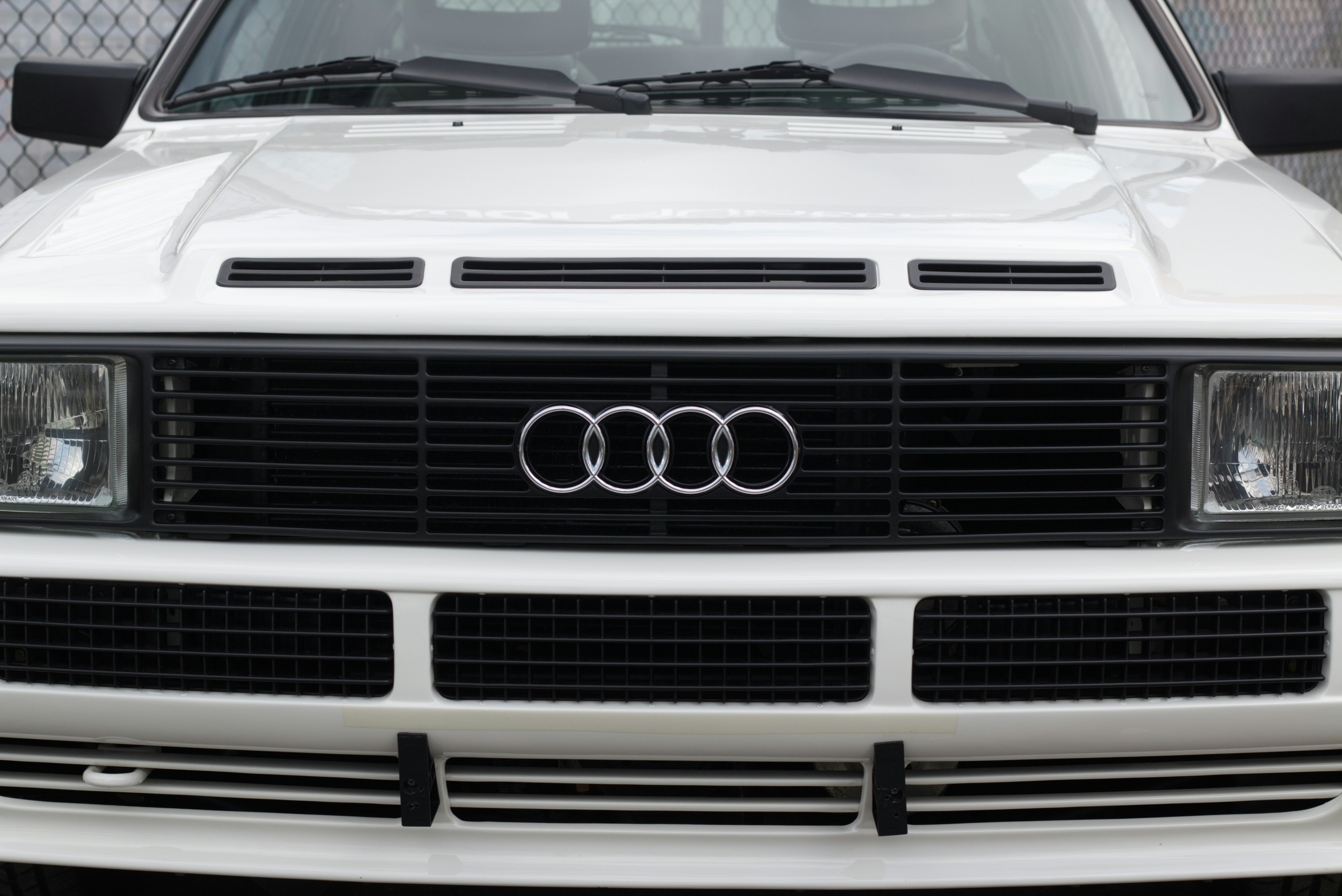 Front Grille Focus: Classic Audi Emblem Framed by White Hood