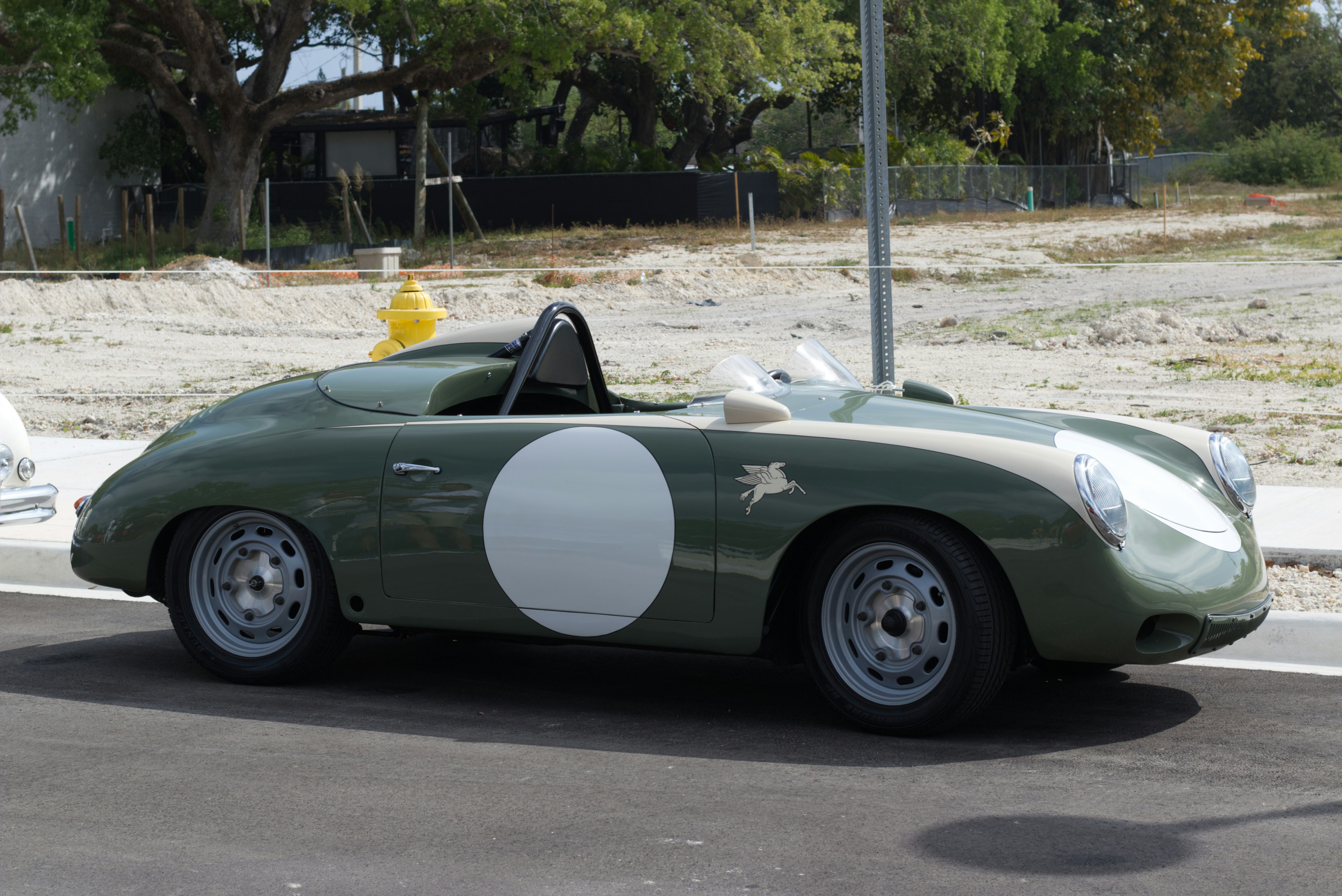Green Vintage Racer with White Dorsal Decal on Sunlit Street