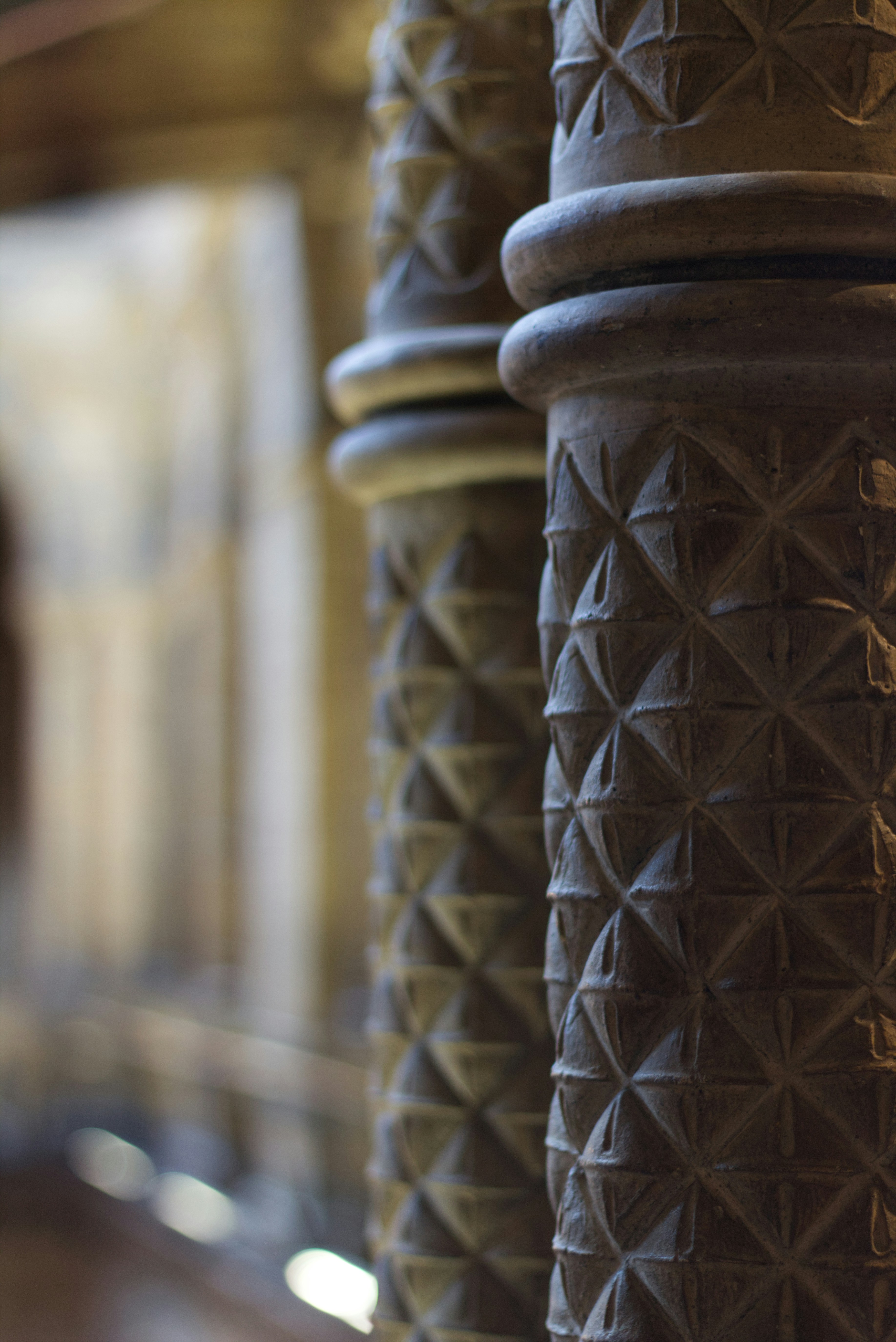 Carved Columns: Geometric Patters on a Dim Corridor