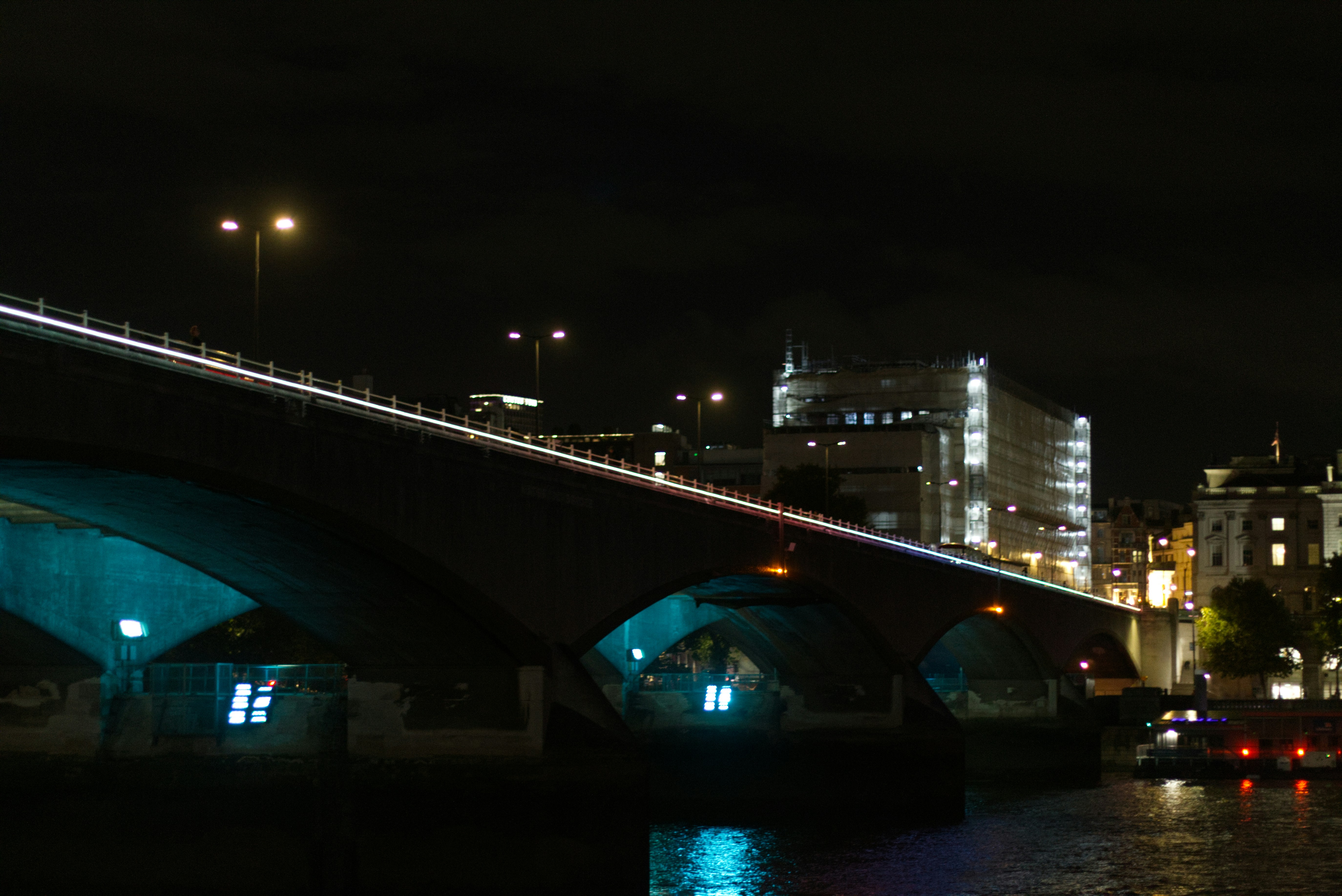 Nighttime Arc: Lights Reflect on the Arched Bridge
