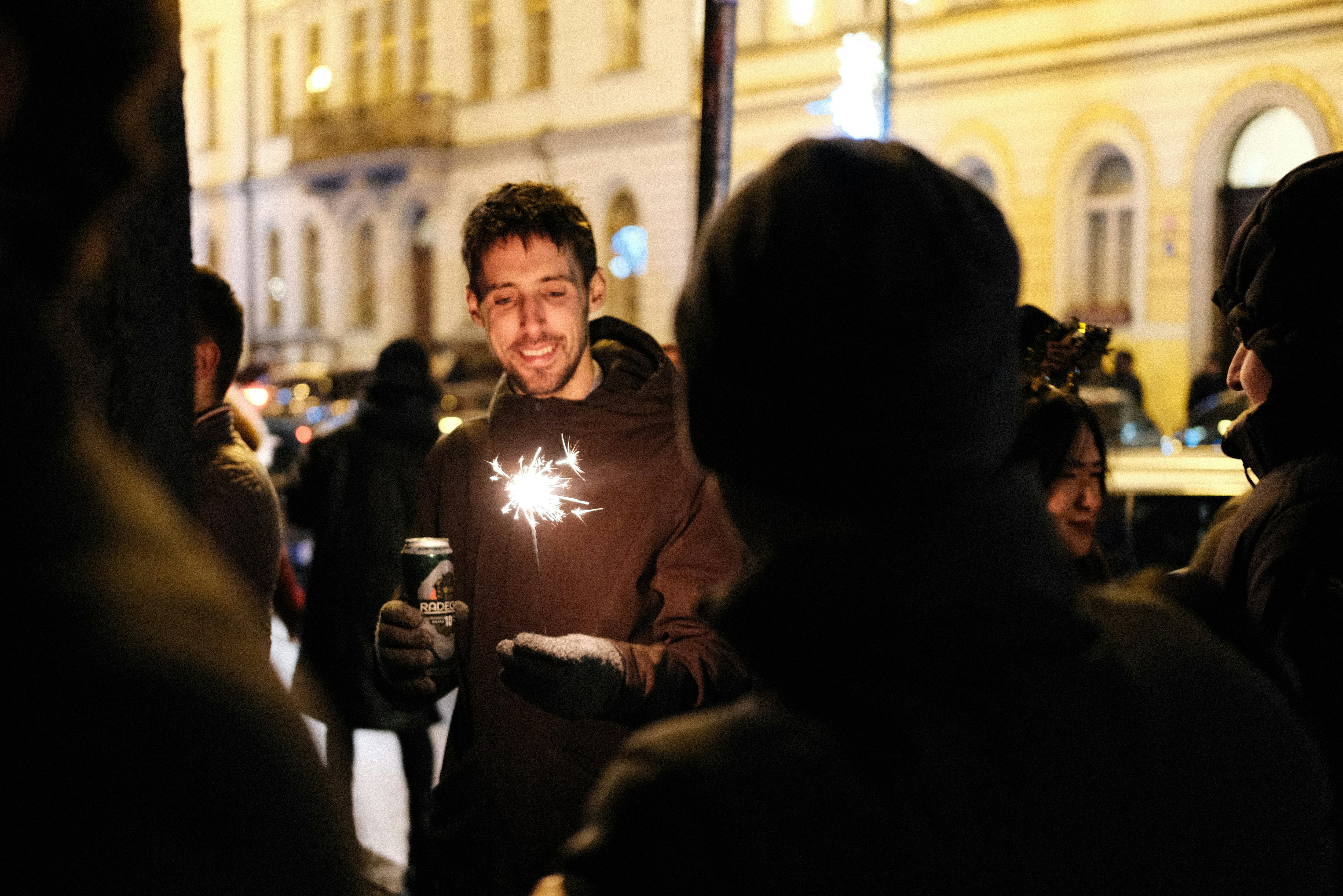 Sparks and Smiles: Nighttime Street Celebration with a Sparkler