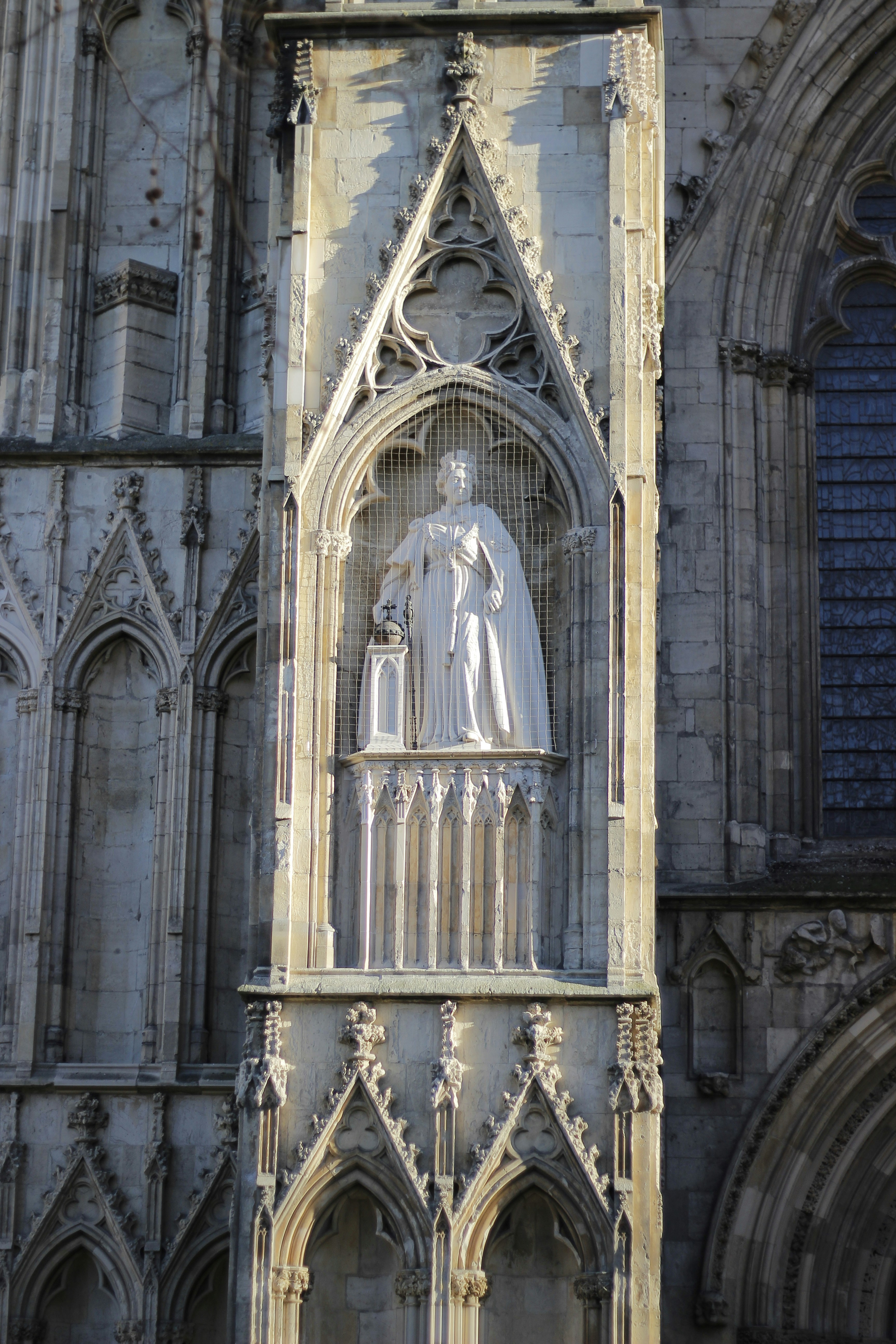Gothic Cathedral Niche: A Quiet Statue Within Stone Arches