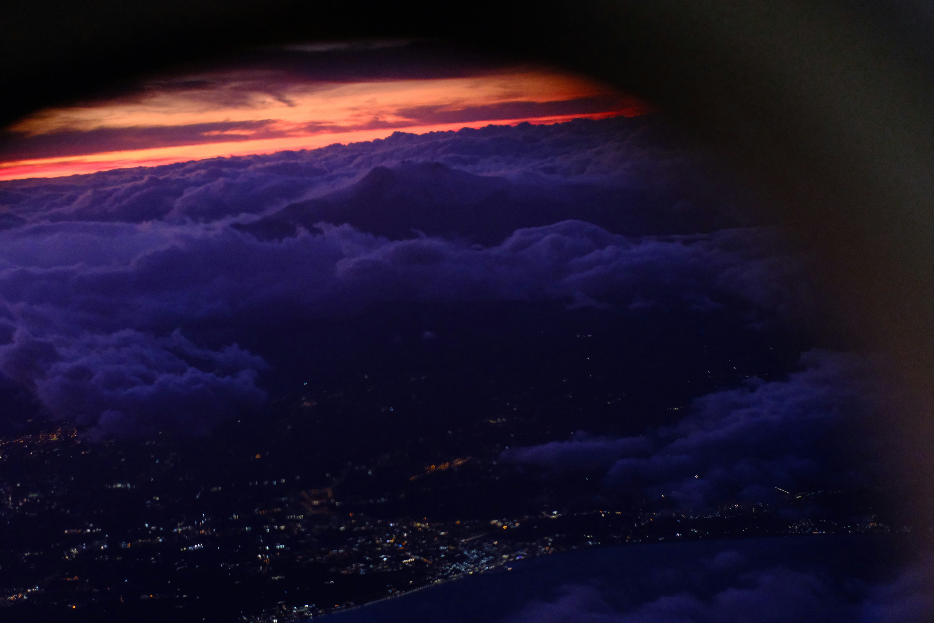 Dawn Above the City: A Sliver of Light Through the Clouds