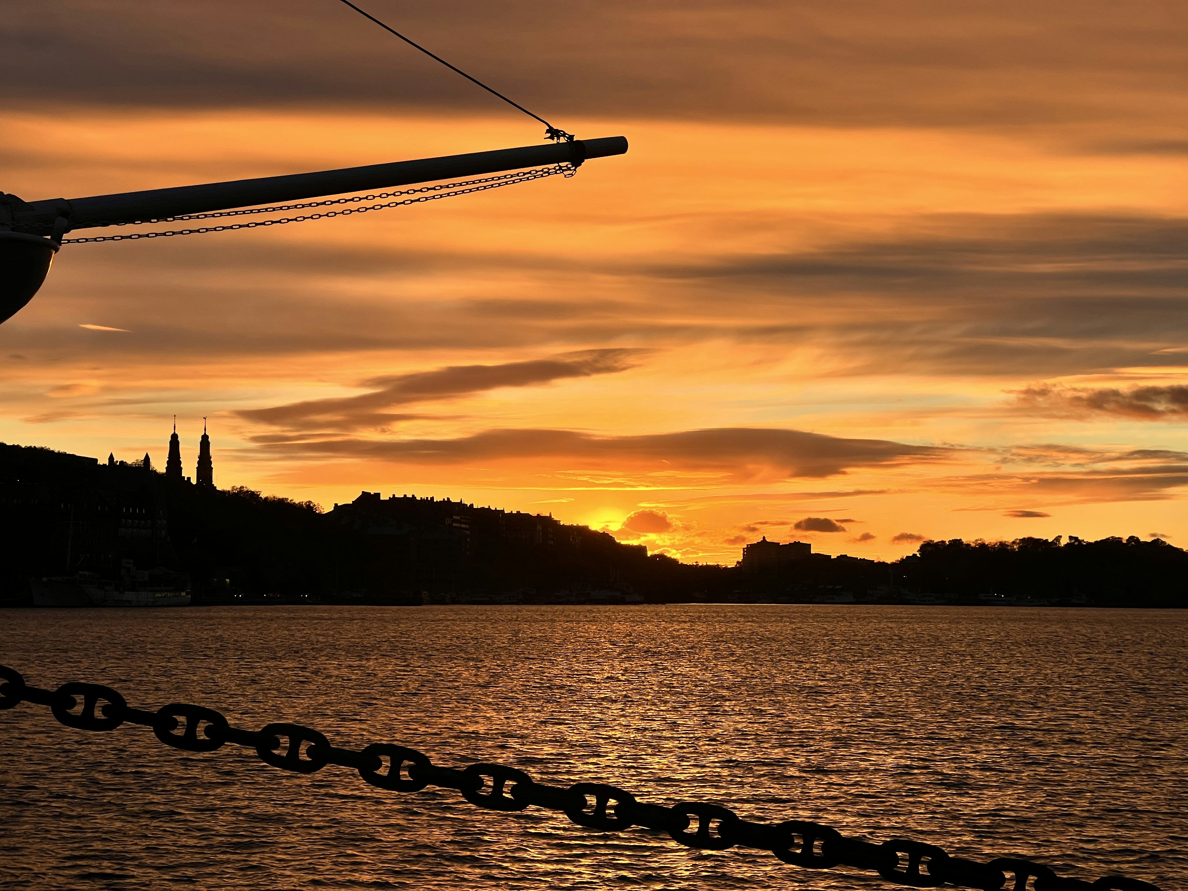 Sunset Sail: Chains and Horizon Silhouette