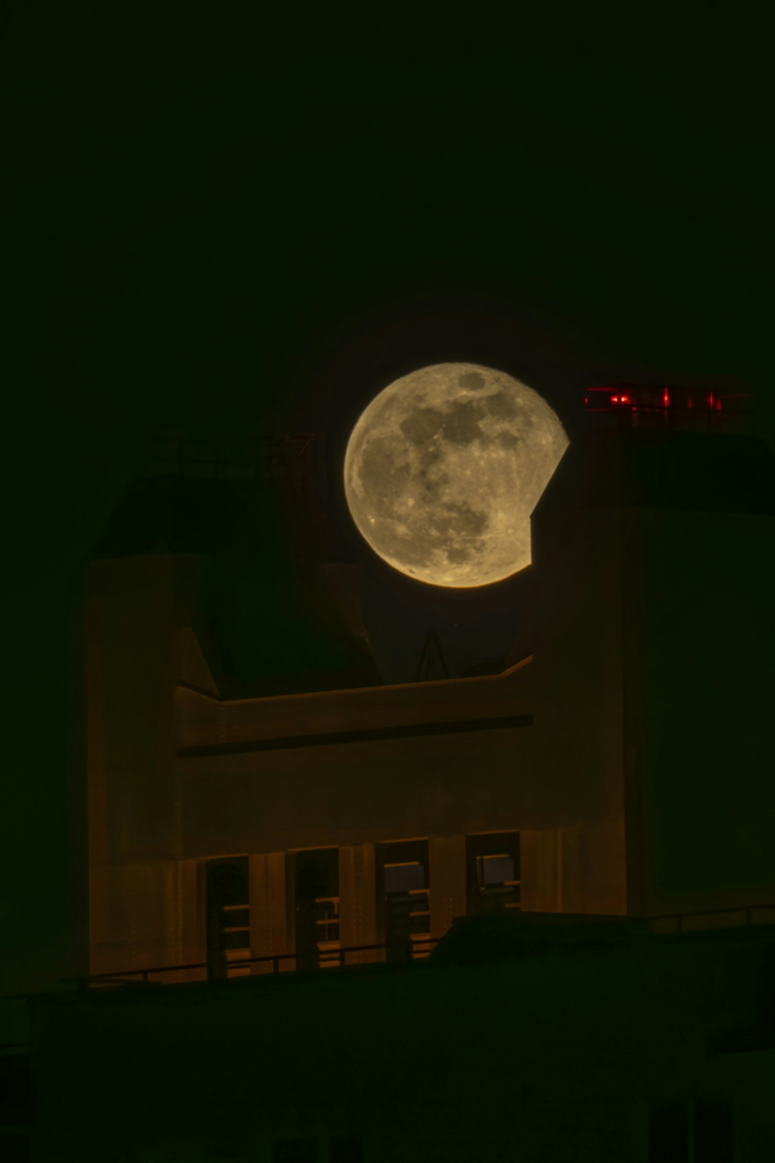 Moonlit Campus: The Giant Orb Over a Quiet Rooftop