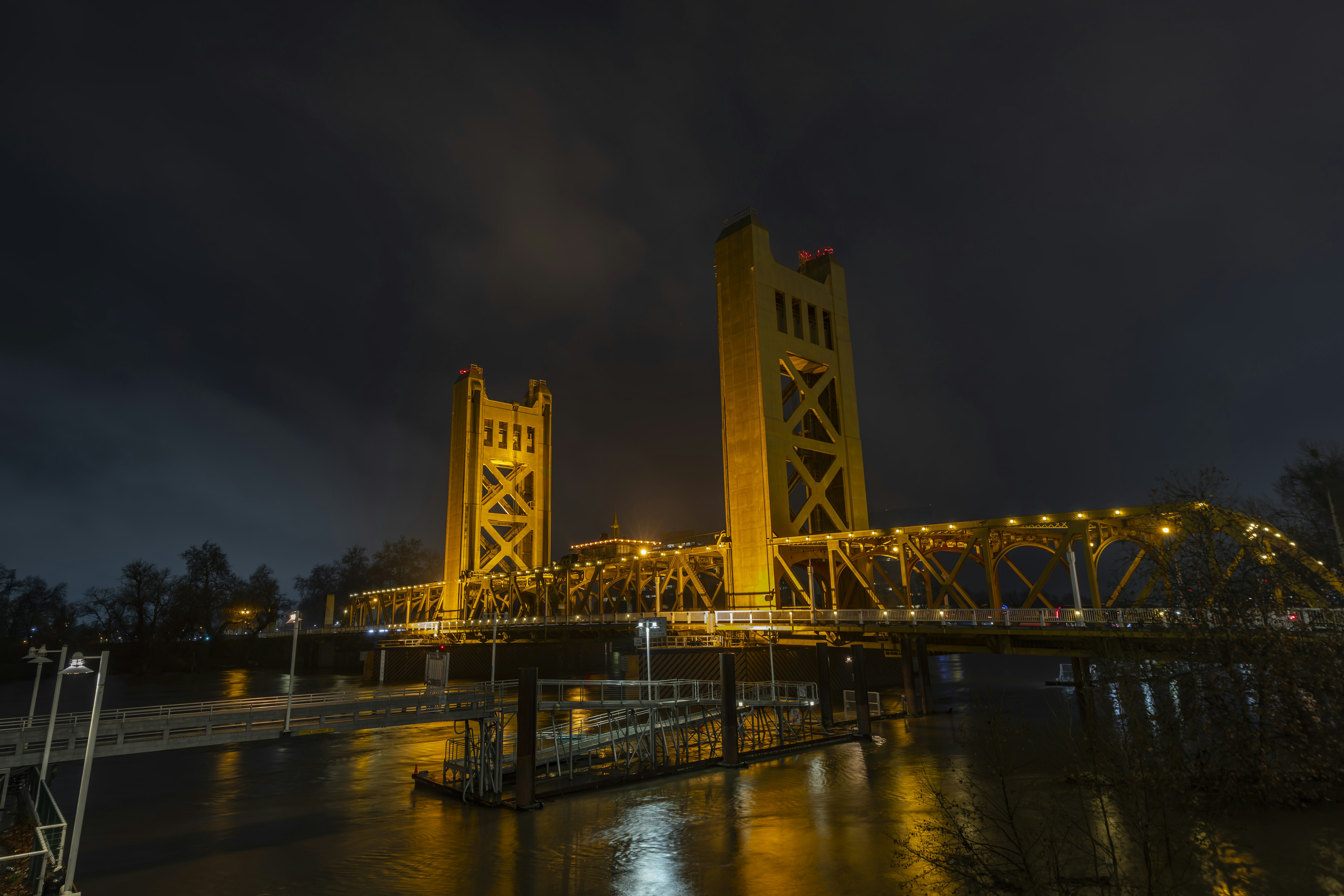 Tower bridge illuminated at night over water