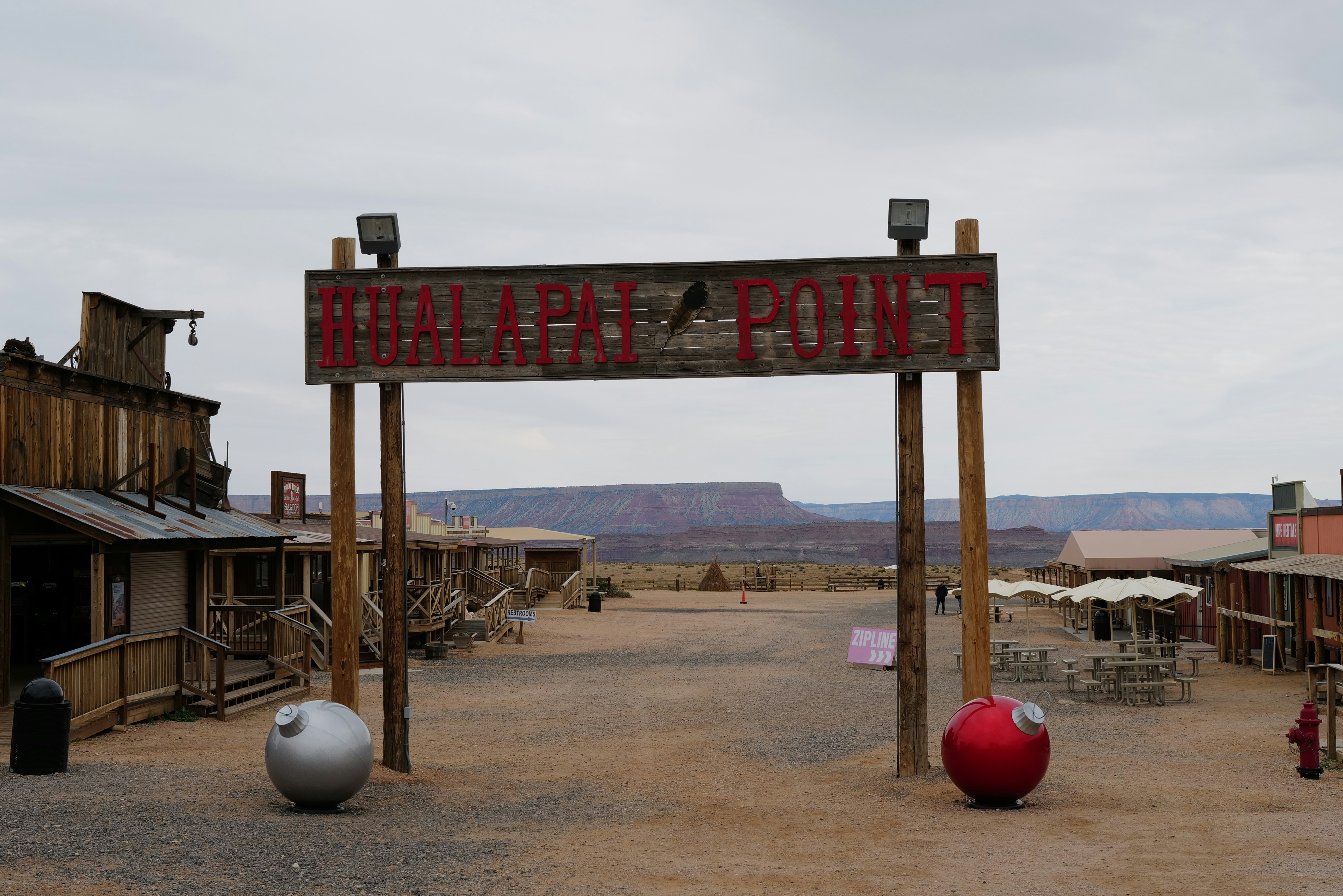 Entrance to a western-themed town with a large sign.