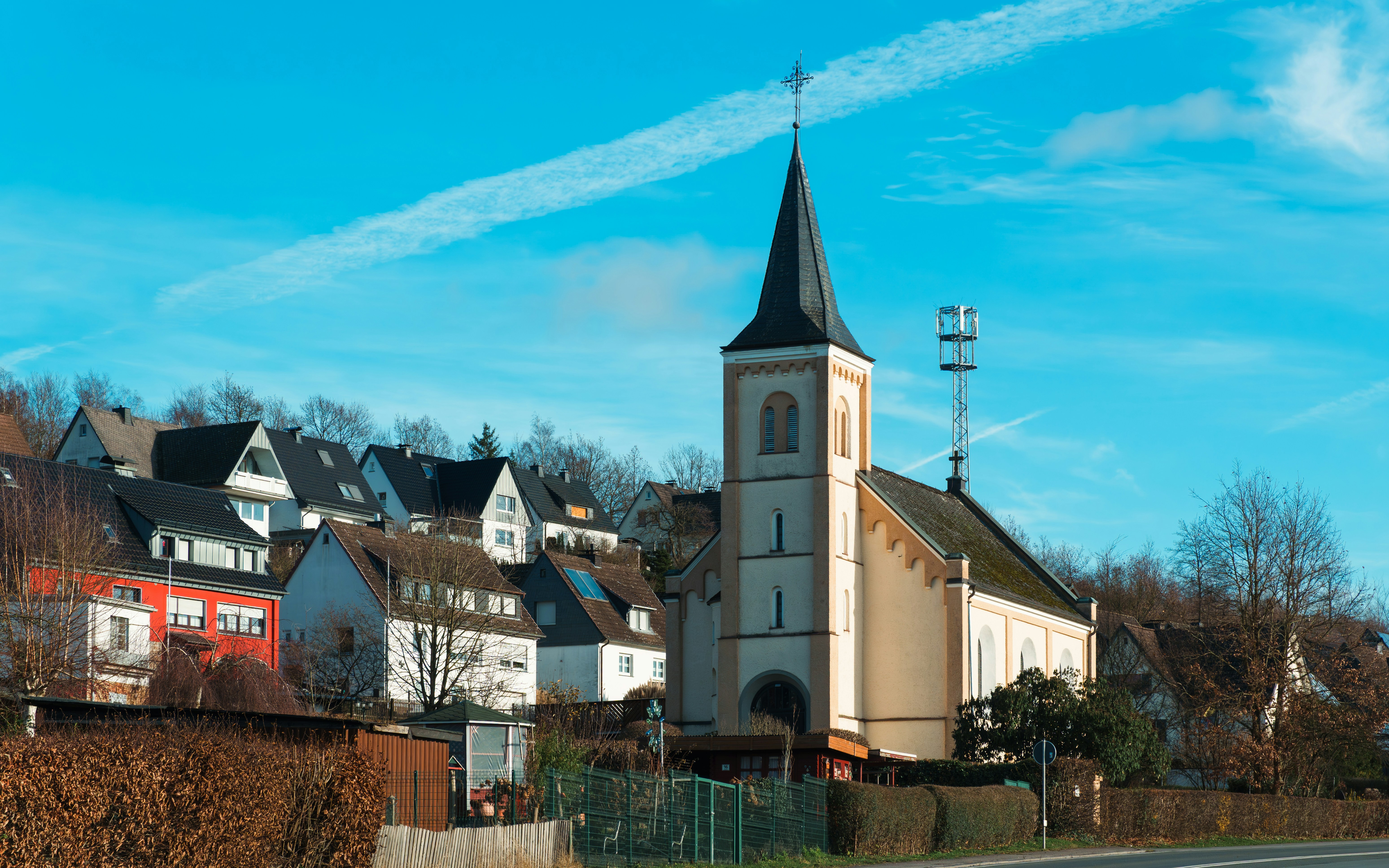 Stately chapel rises above a quiet village hillside