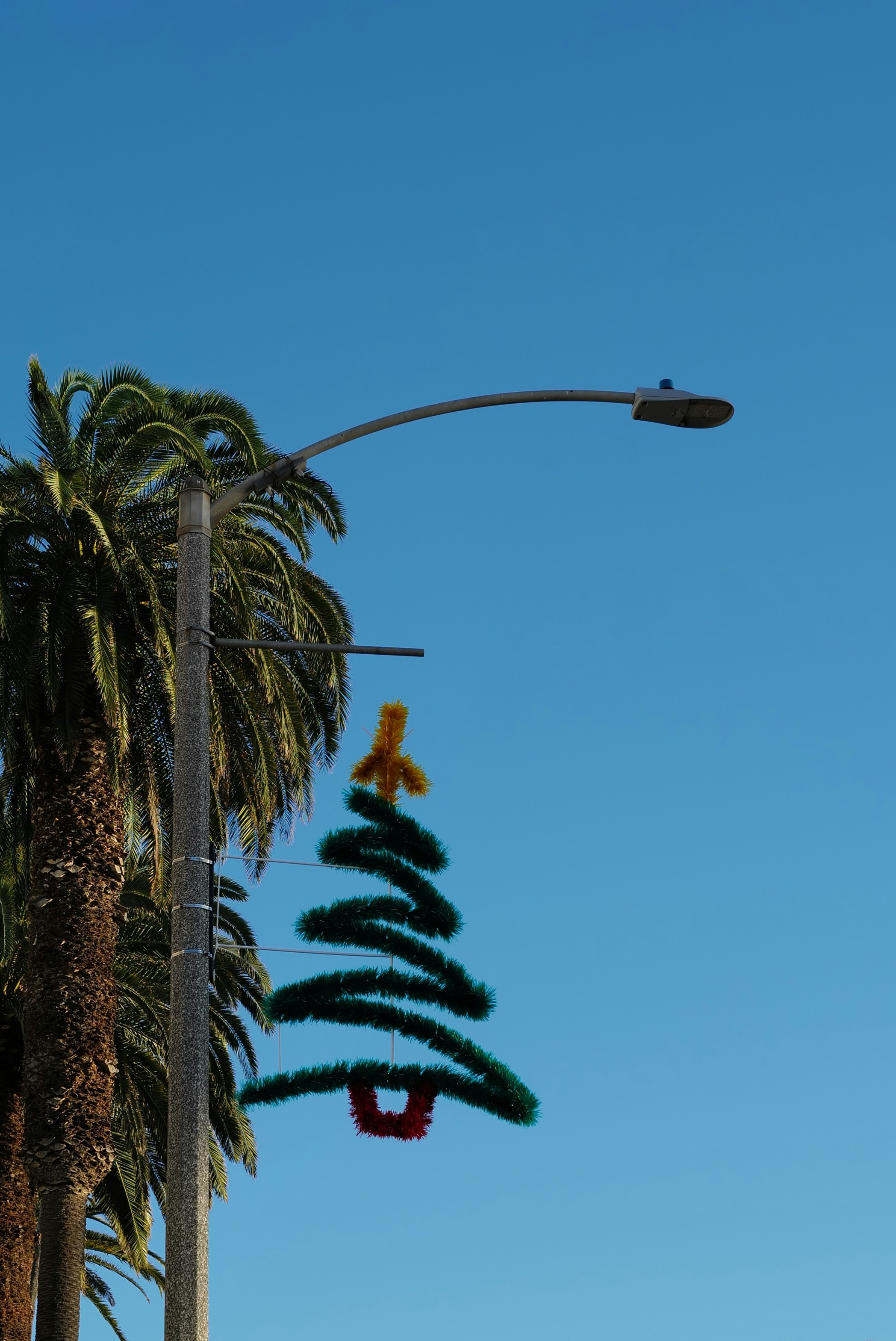 A bright blue sky over a festive street ornament