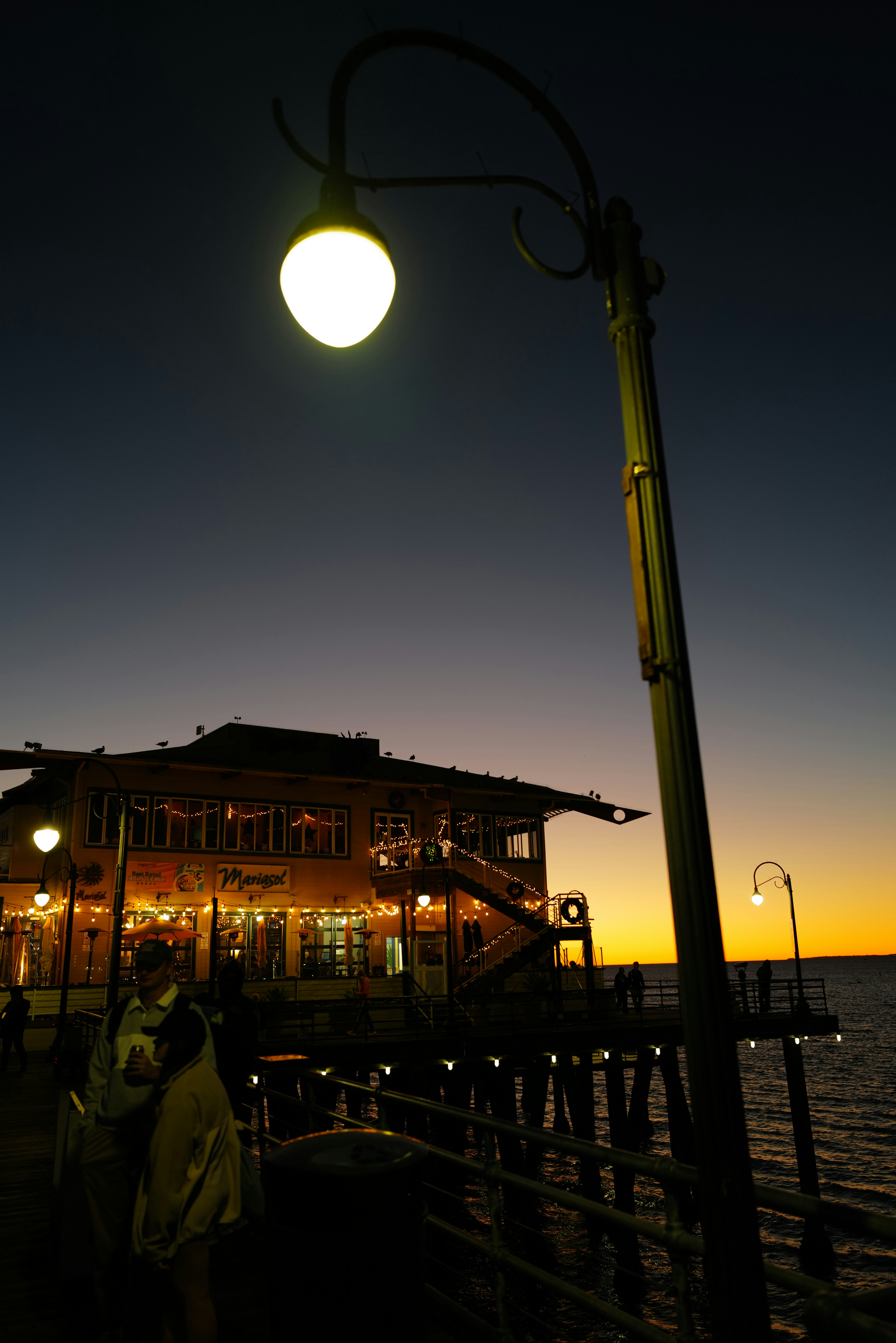 Evening Pier: Lanterns, City Glow, and the Quiet Horizon