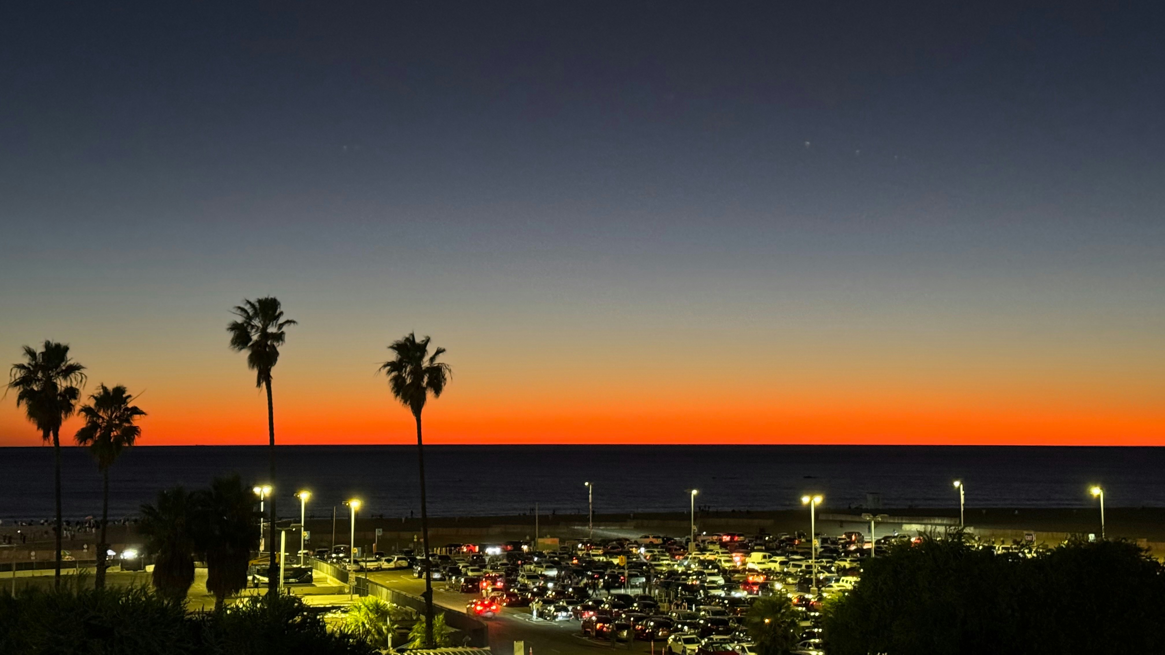 Sunset Strip: Horizon Fire Over a Busy Coastal Parking Lot