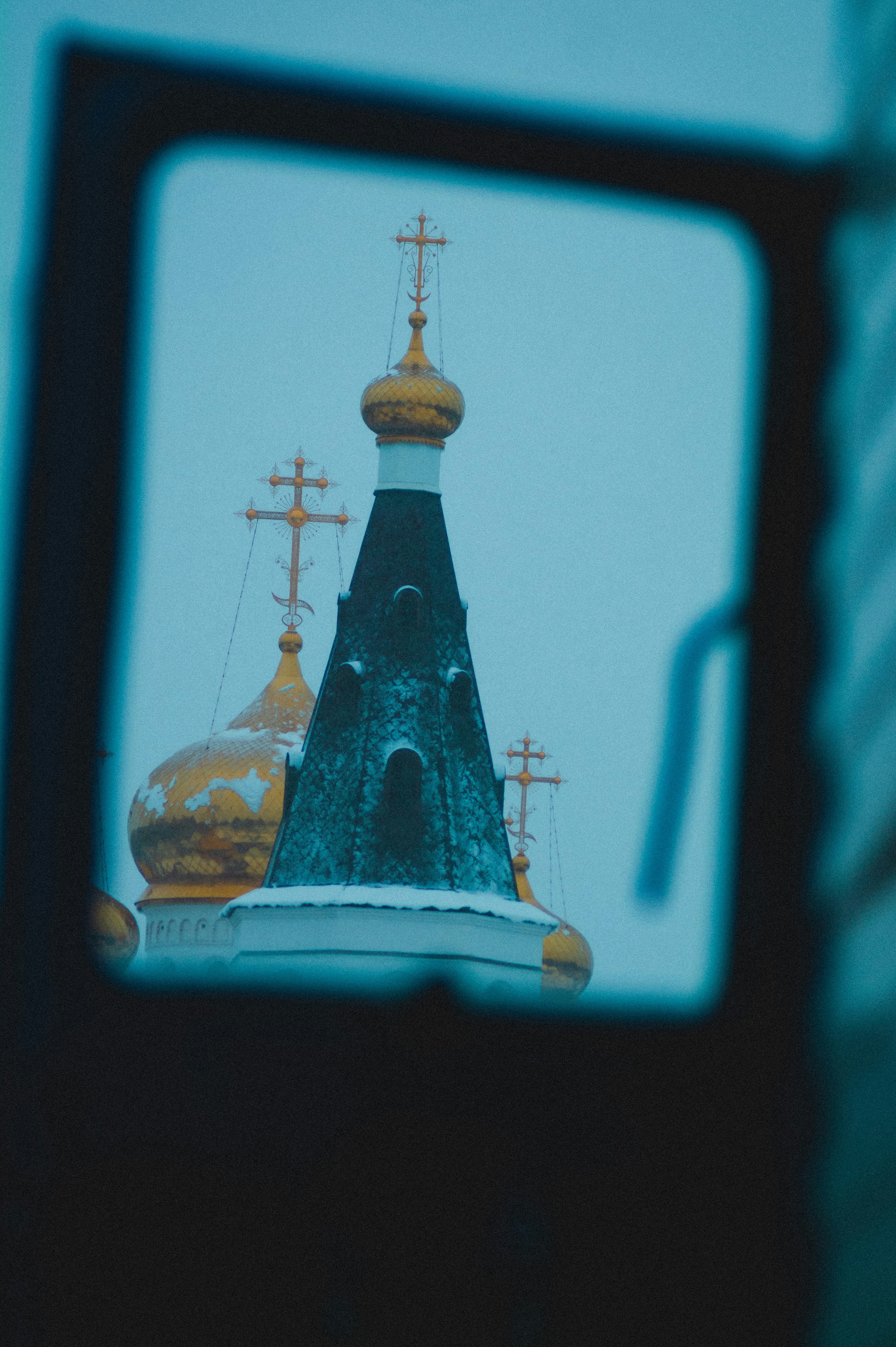 Church domes seen through a window frame.