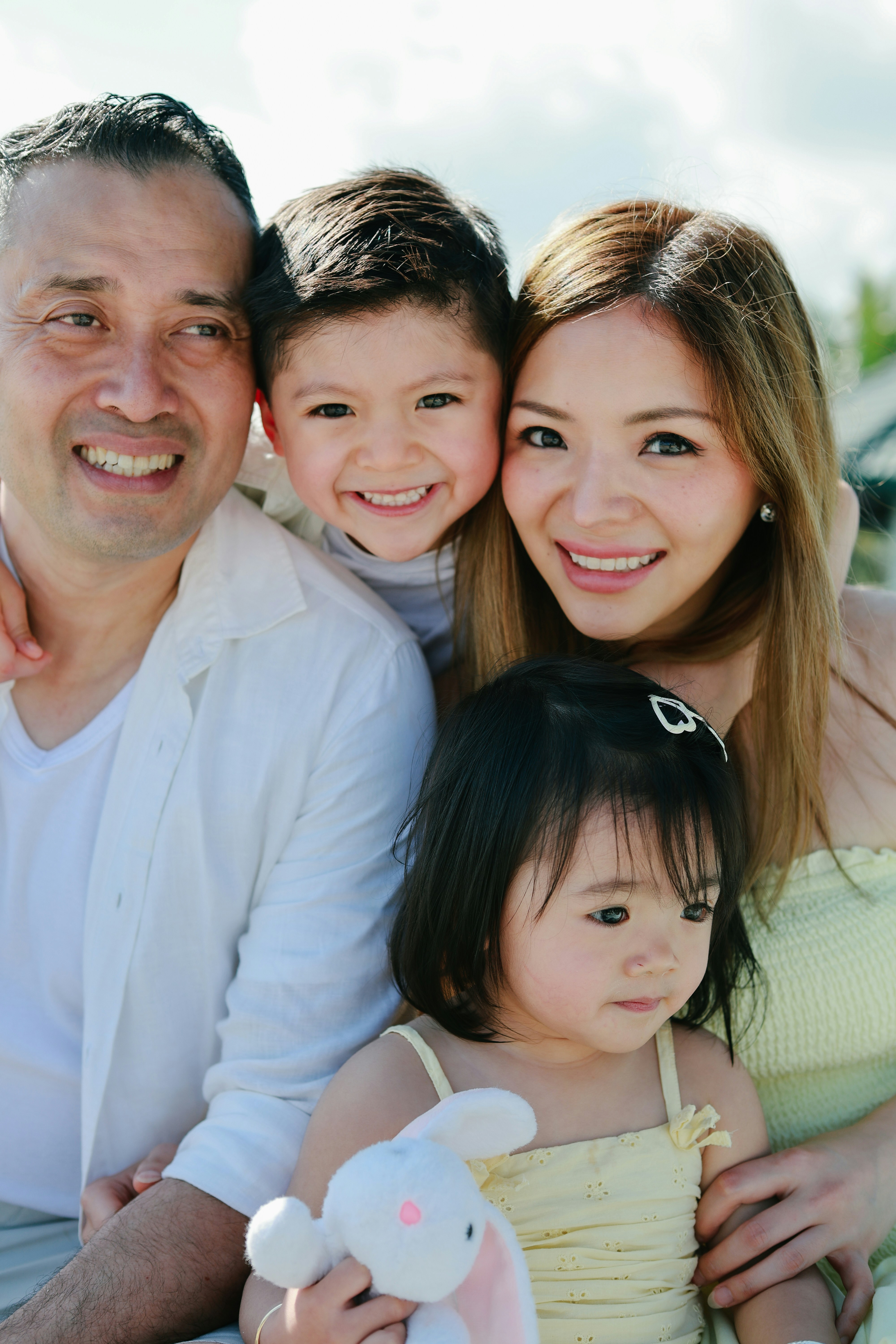 Sunlit Family Portrait: Close-Knit Cheer Under a Clear Sky