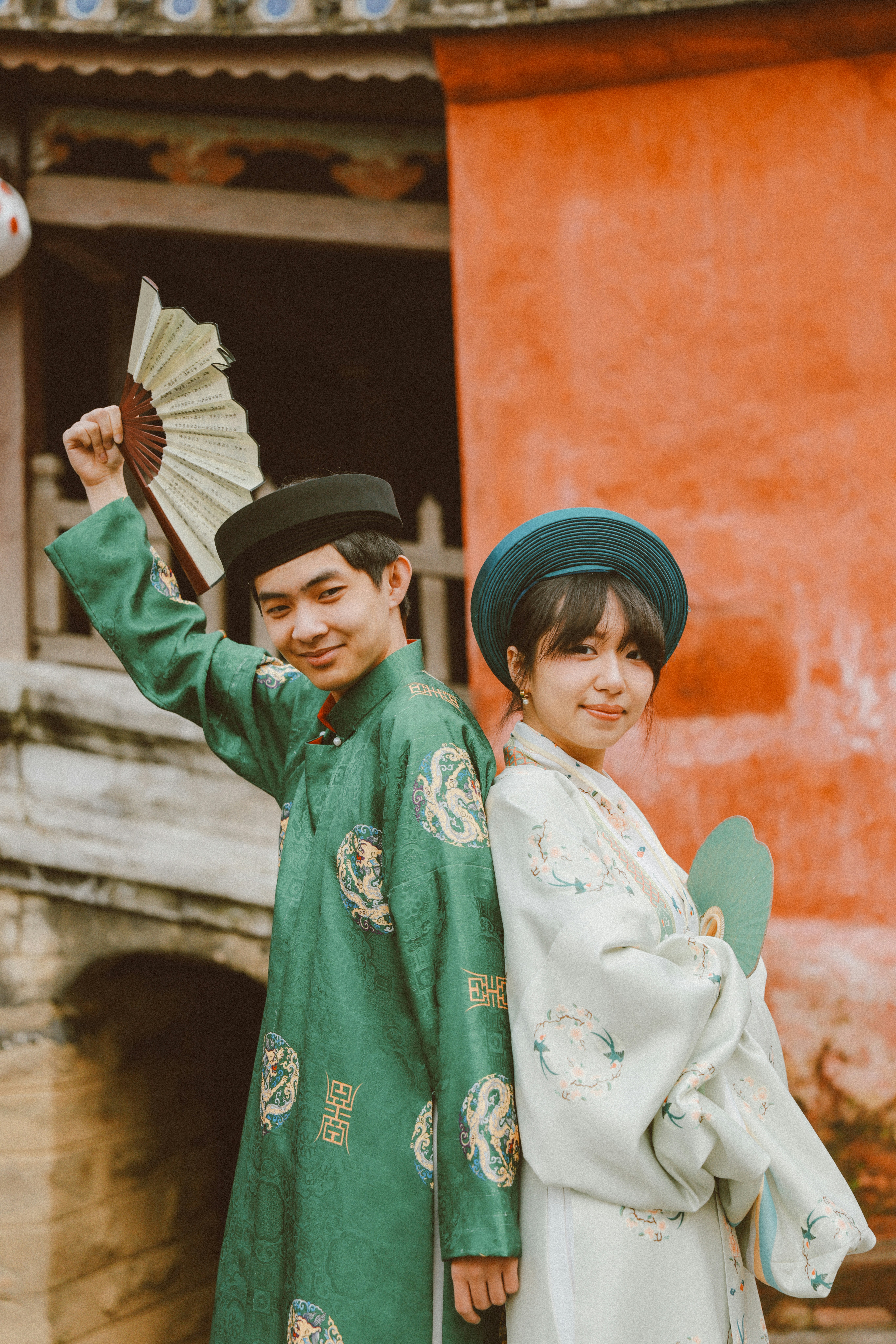 Two Traditional Attire Portrait Backed by Warm Terracotta Wall