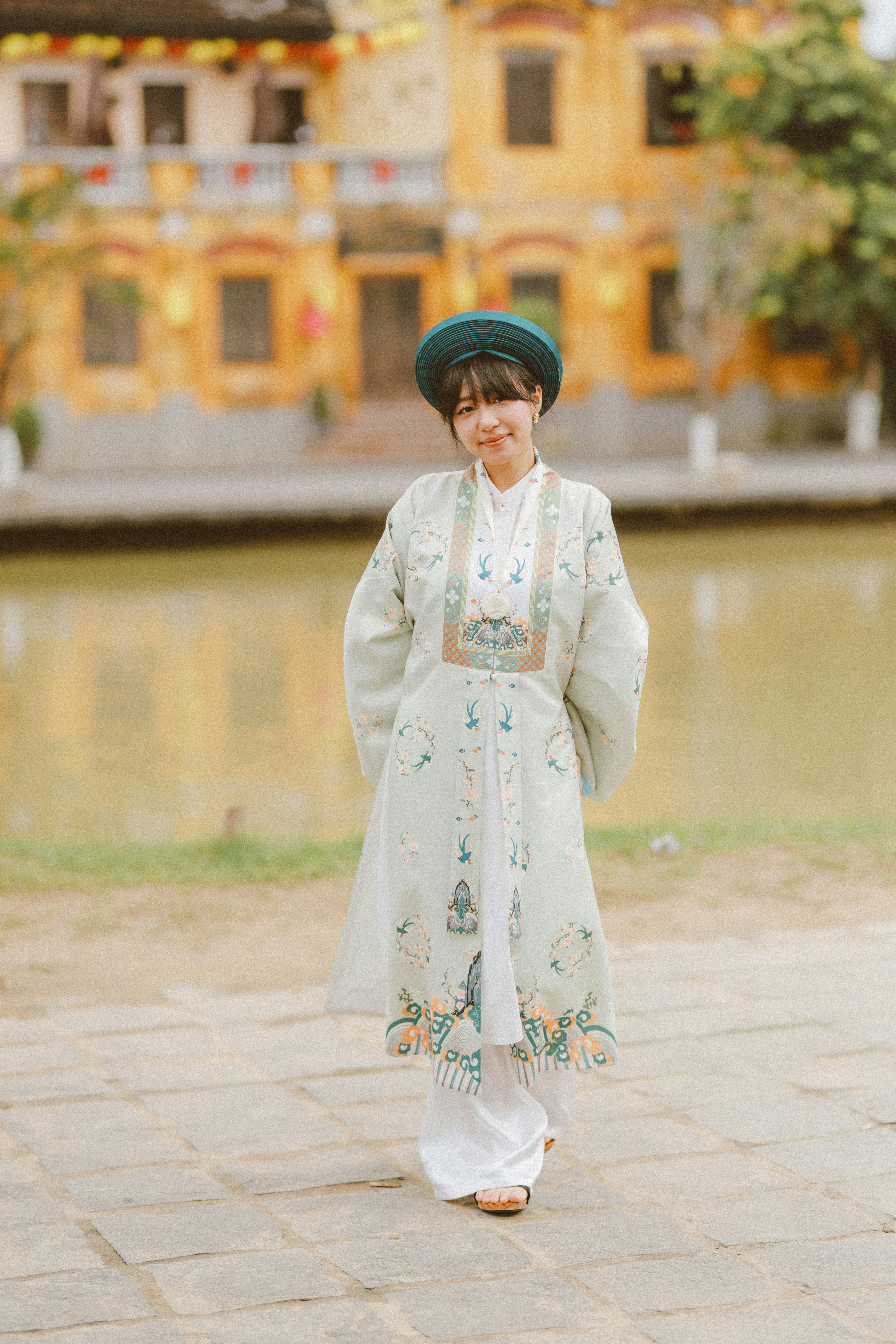 Graceful in Traditional Attire by Riverside Courtyard