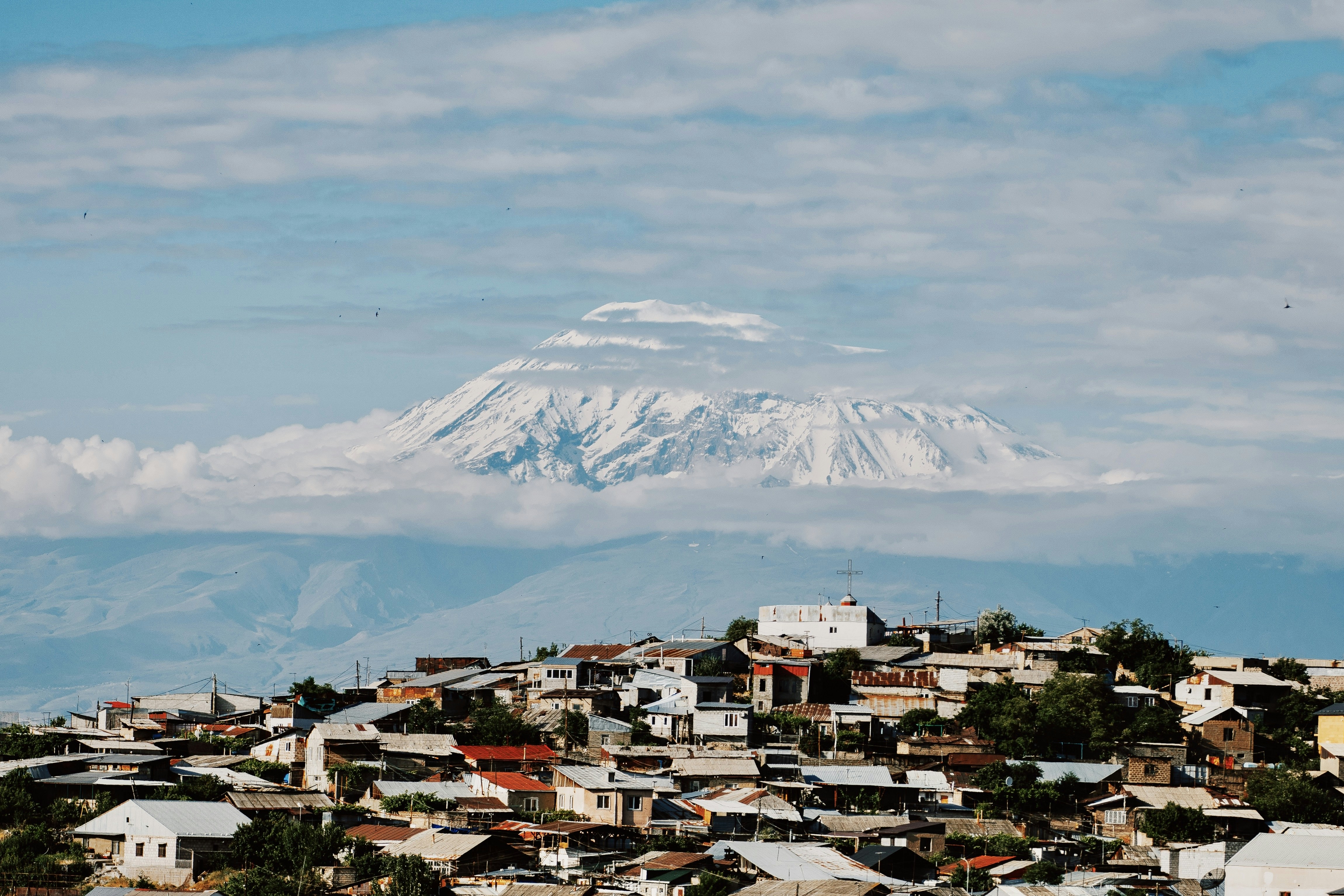 Snow-Capped Peak Above a Patchwork Town