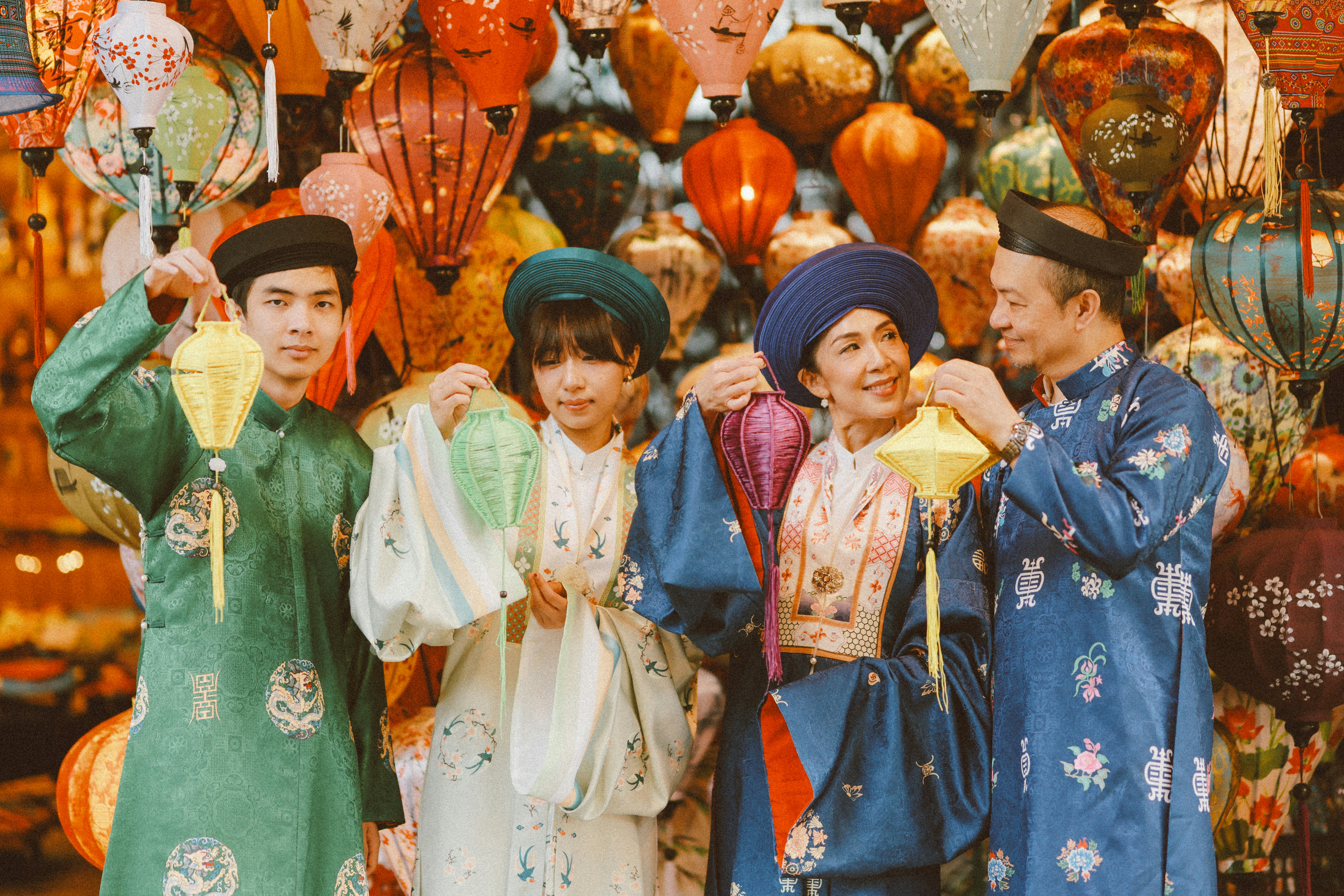 Vibrant Lantern Walk: Friends in Traditional Attire Among Colorful Ornaments