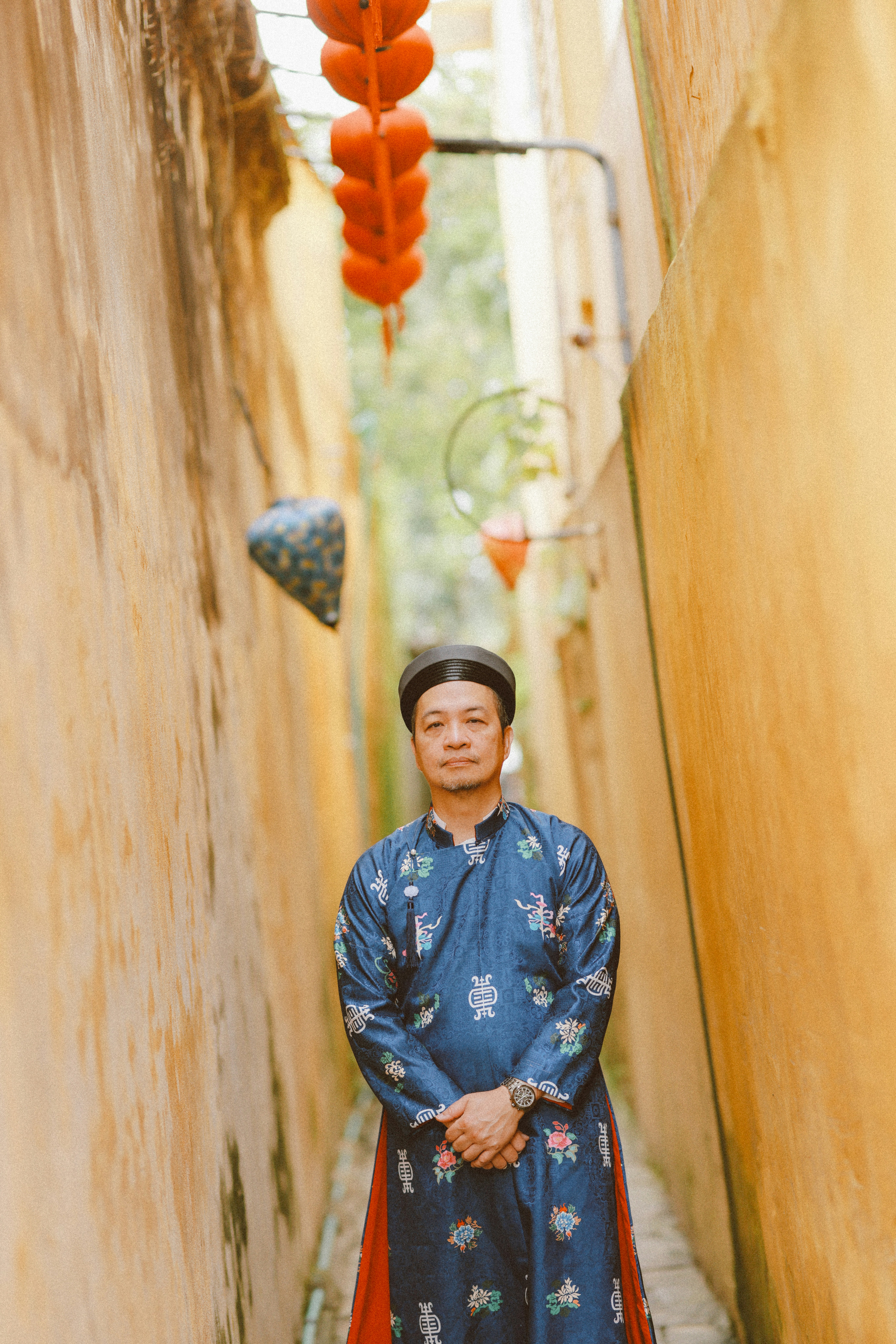 Blue Robe in a Sunlit Alley Between Warm Walls