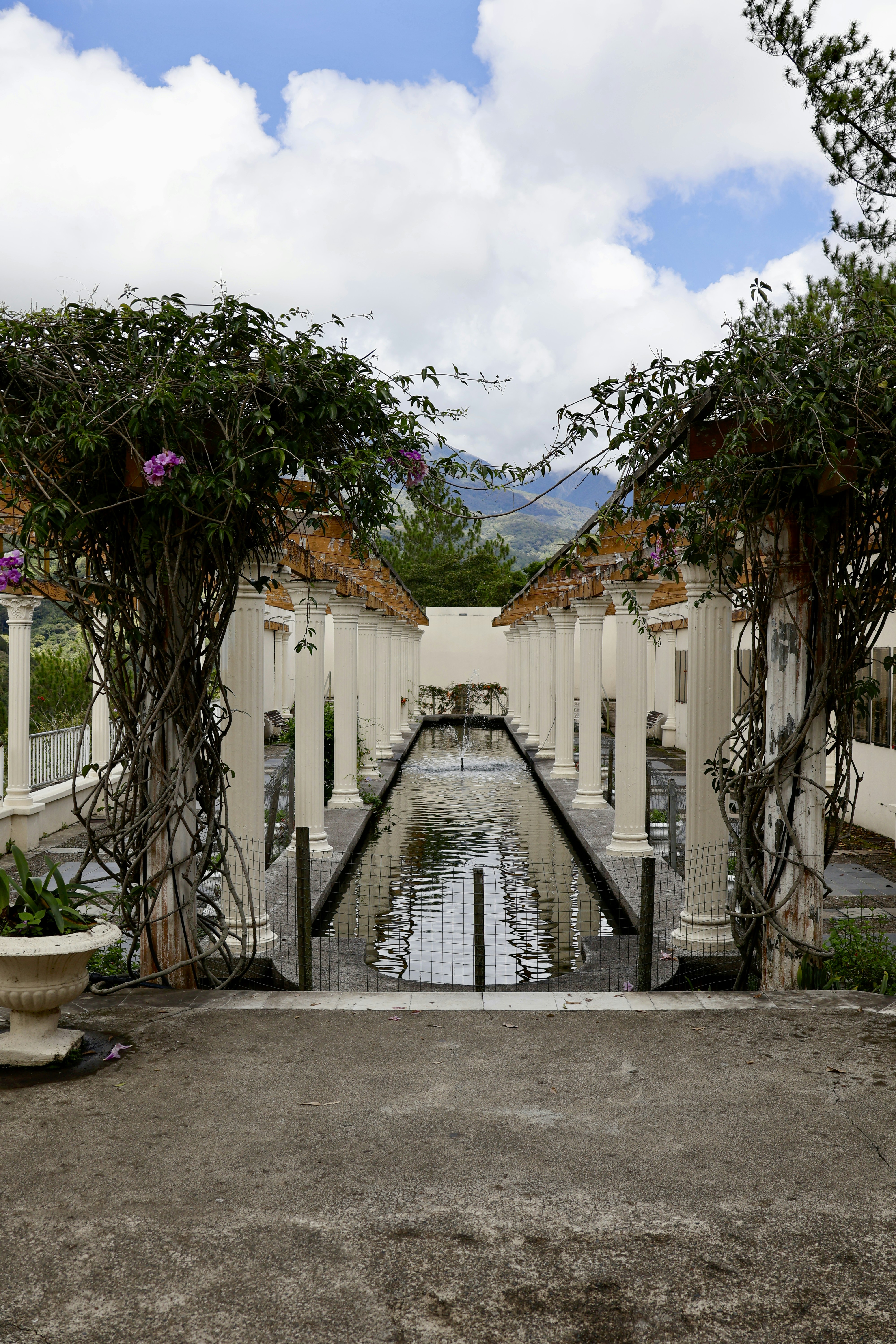 Symmetrical Waterway Framed by Pergola Arches