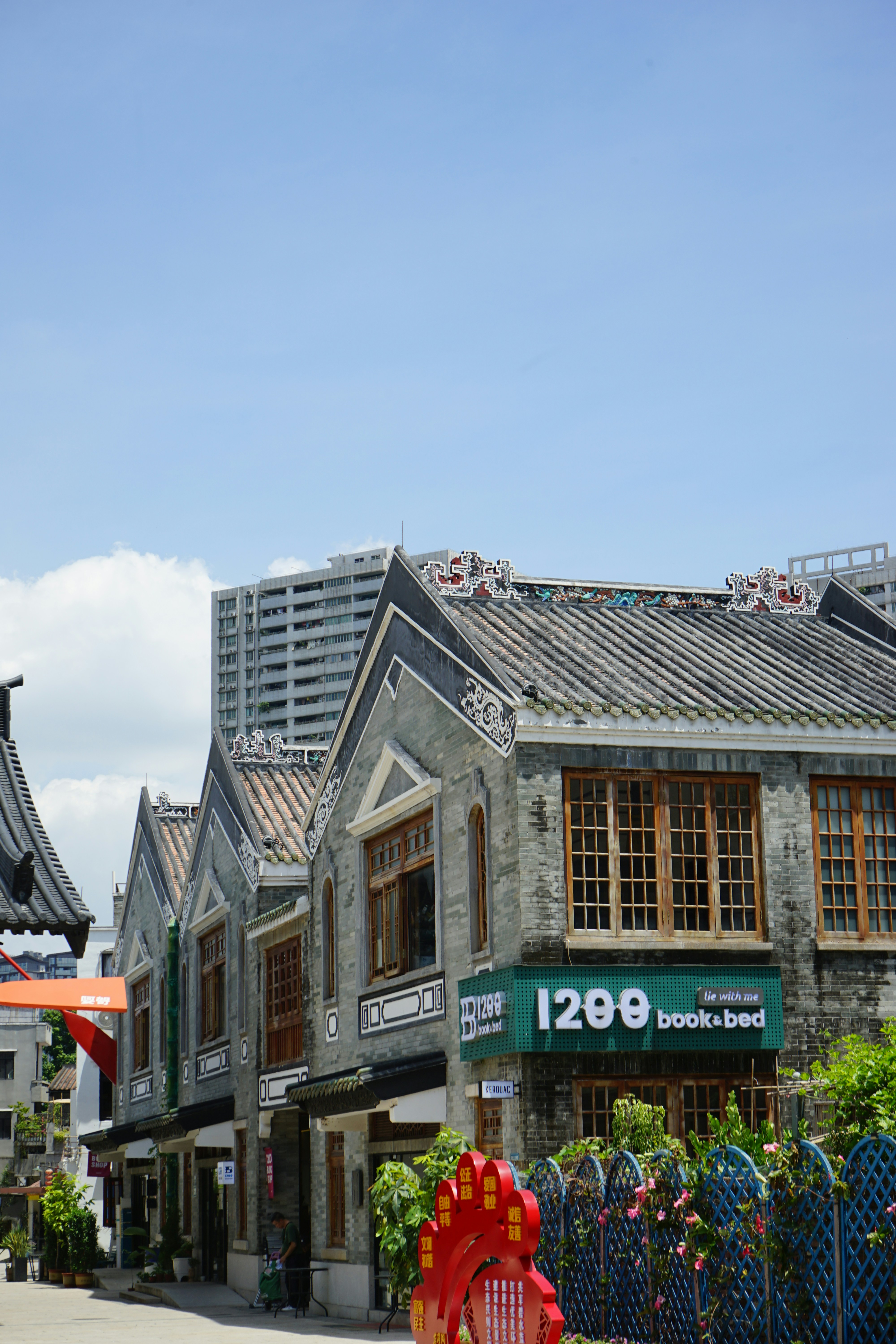 Heritage storefronts under a clear sky on a sunlit street