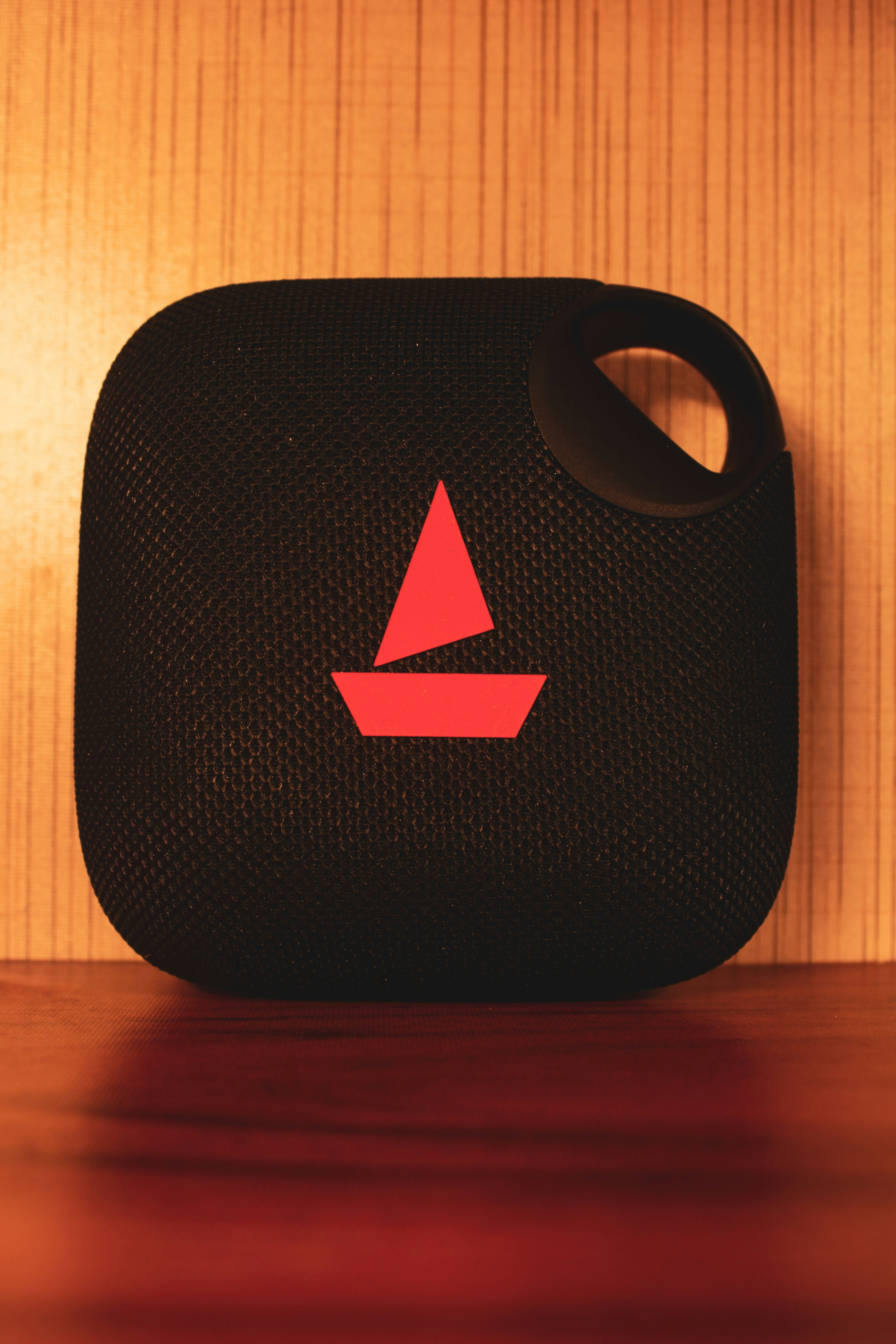 Red Sail Speaker on Wooden Backdrop
