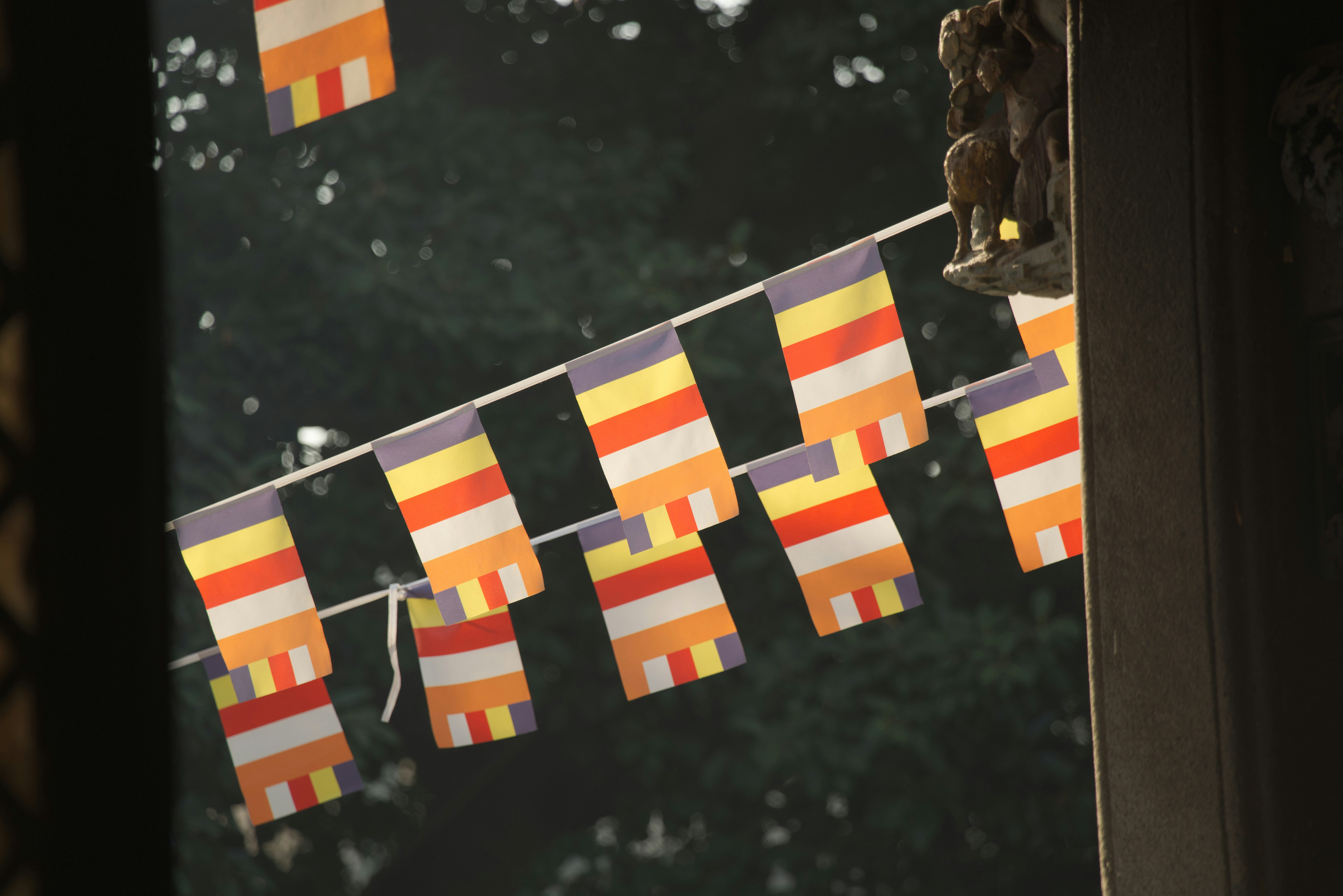 Strings of Color: Prayer Flags Framing a Quiet Shrine