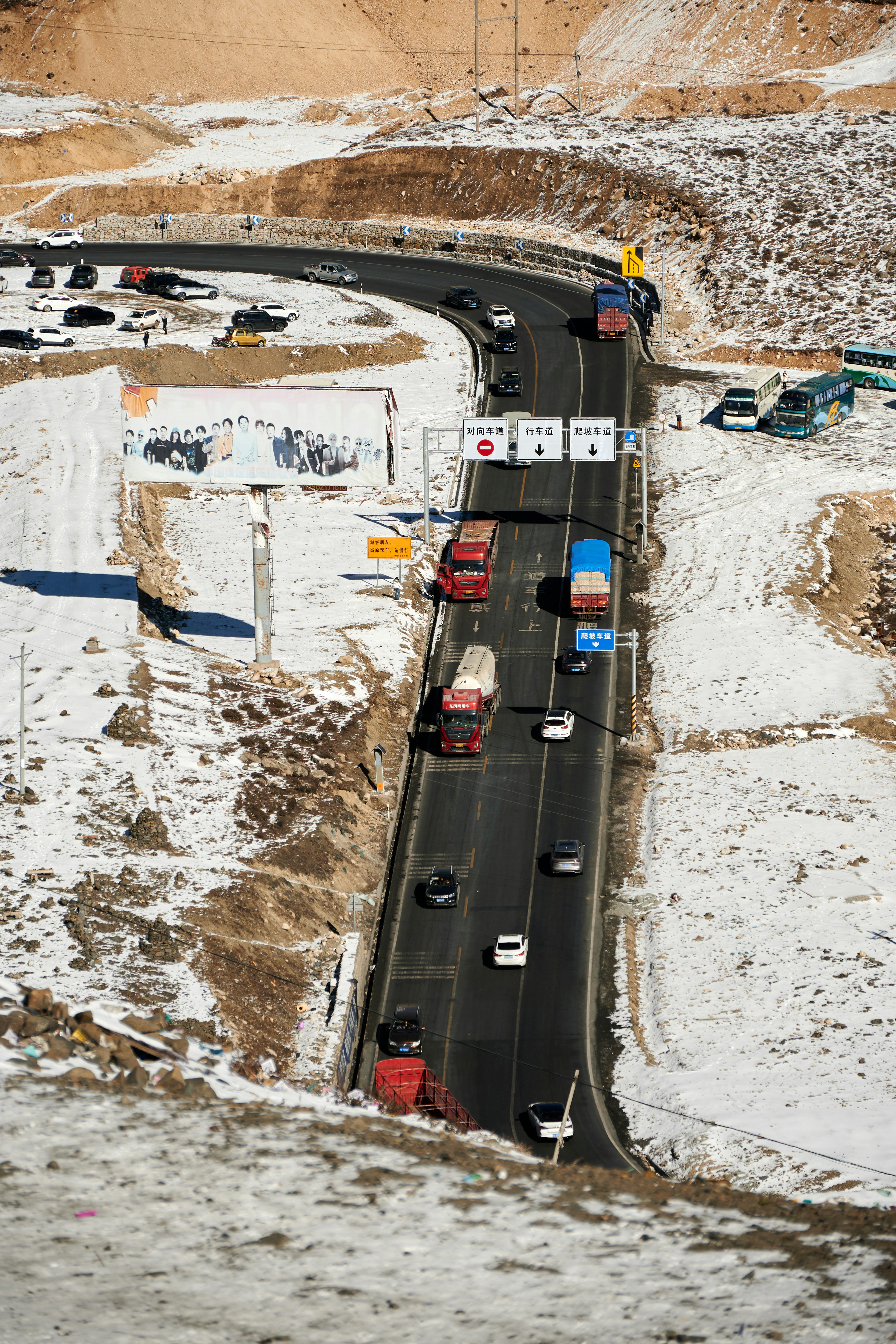 Snowbound Highway: Aerial Traffic Wollows Through a Mountain Pass