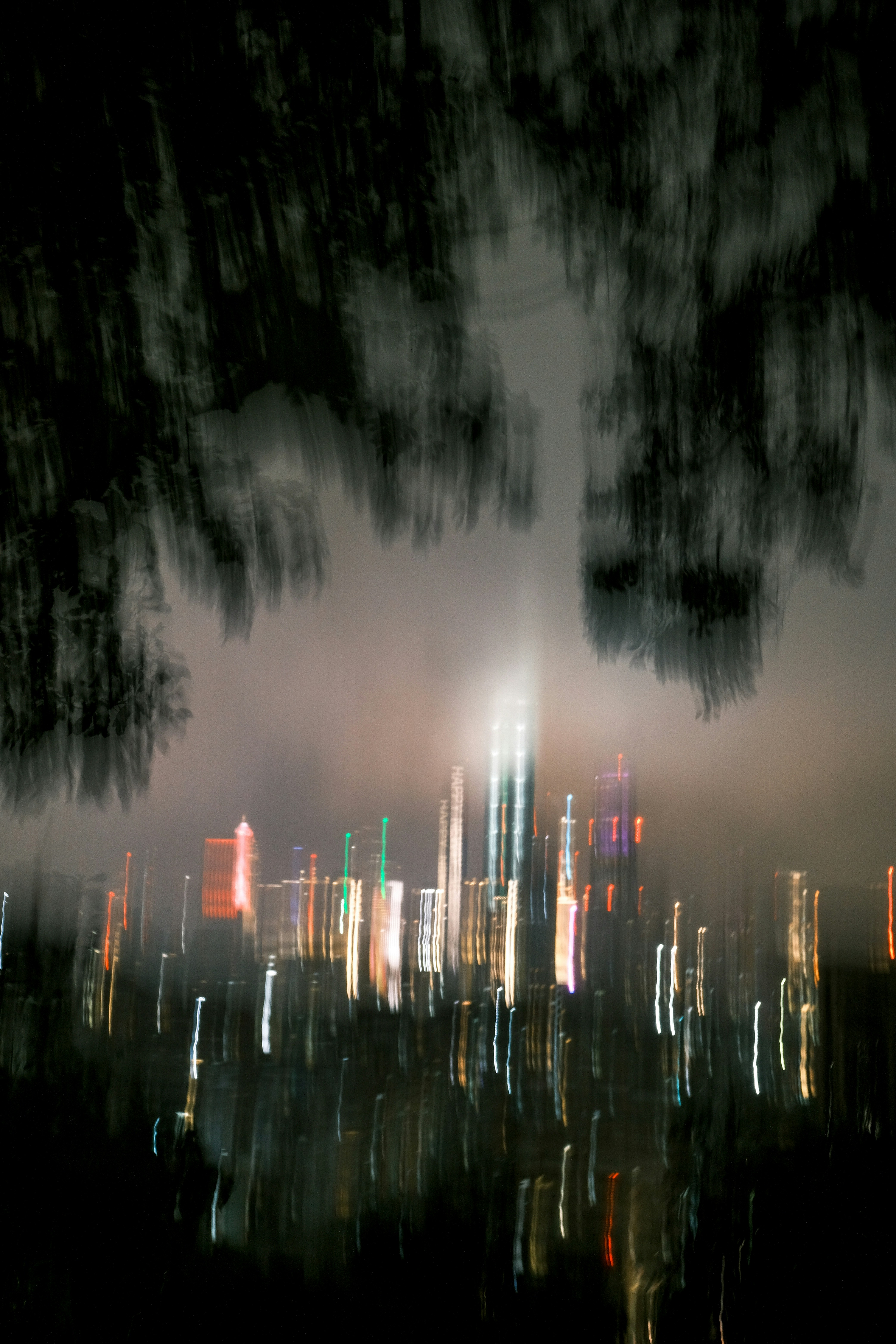 Neon Mirage: Distant Skyscrapers Blur into Night Mist