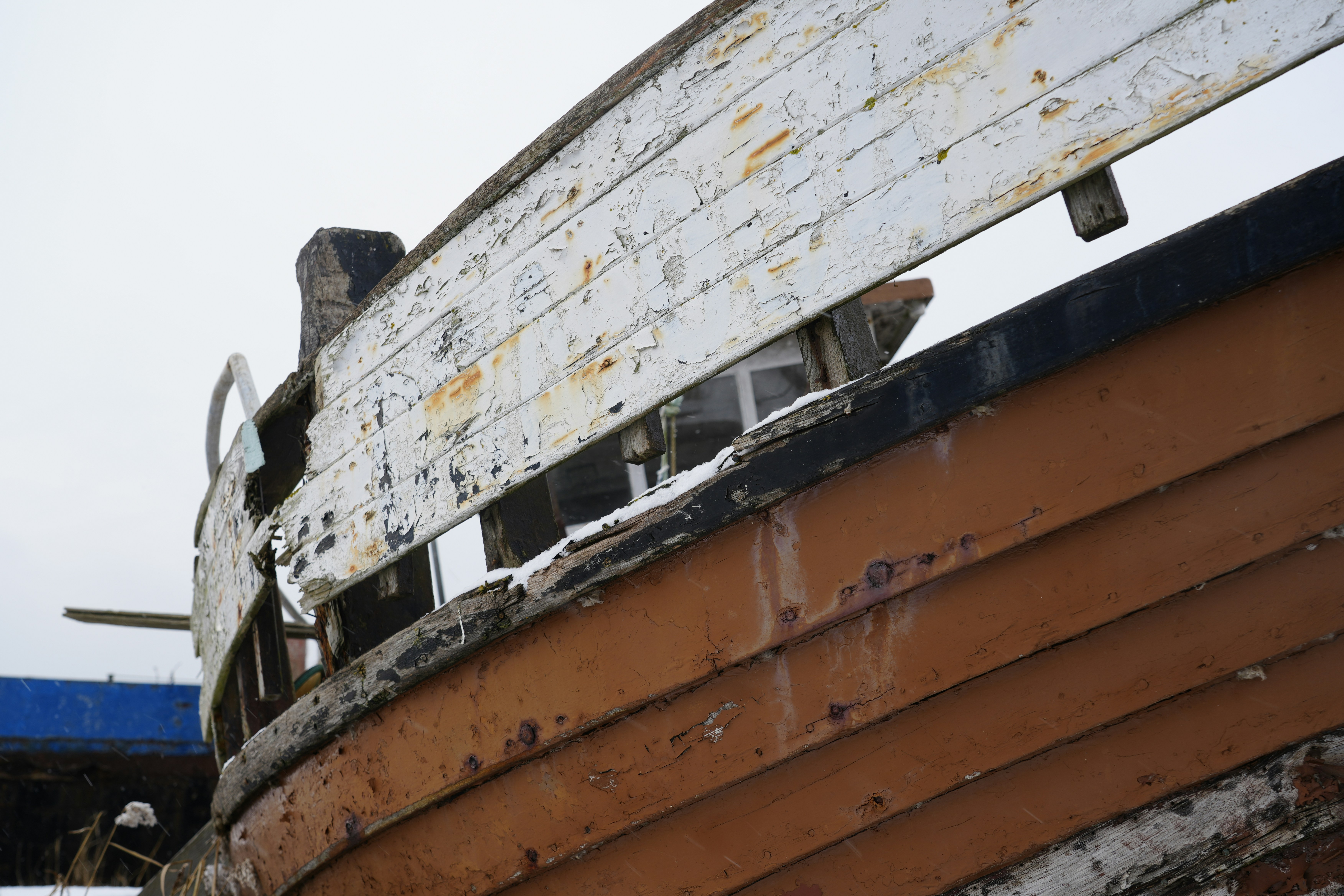 Weathered Vessel: A Curved Bow Revealing Timeworn Wood and Rust
