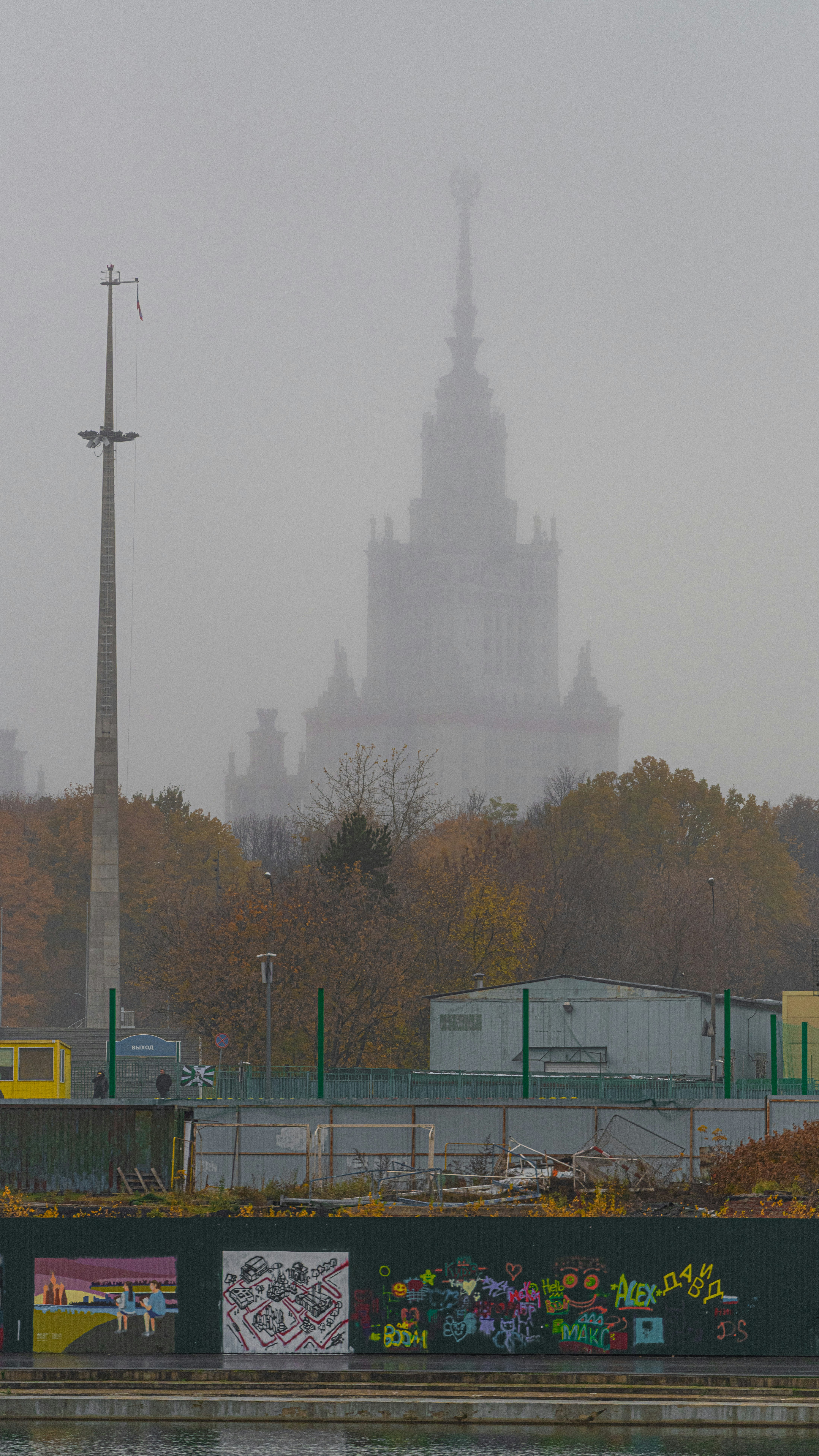 Misty Tower: A Quiet Moment Between Foreground Urban Decay and a Distant Peak