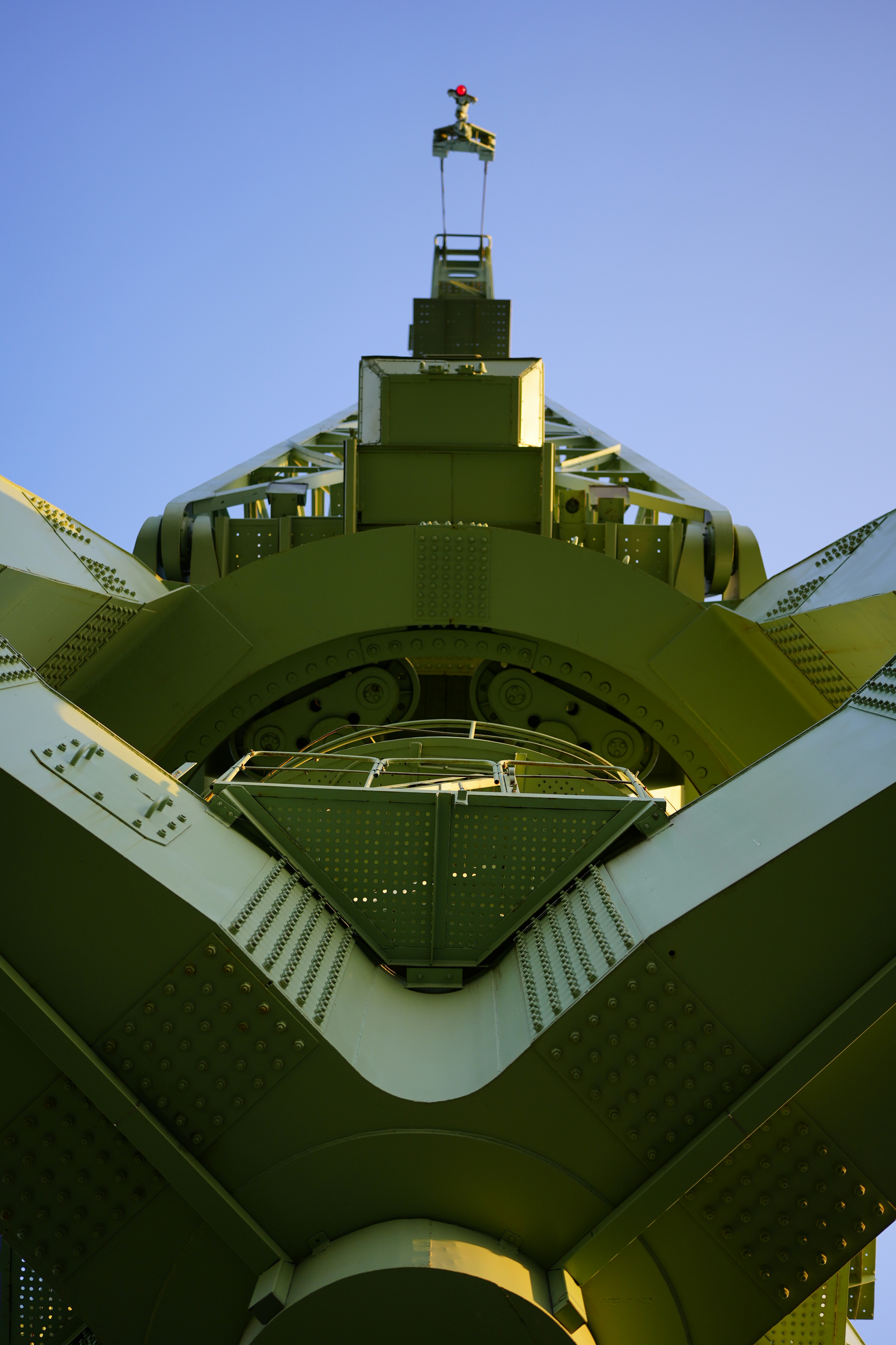 Upward Gaze at a Green Structural Spire