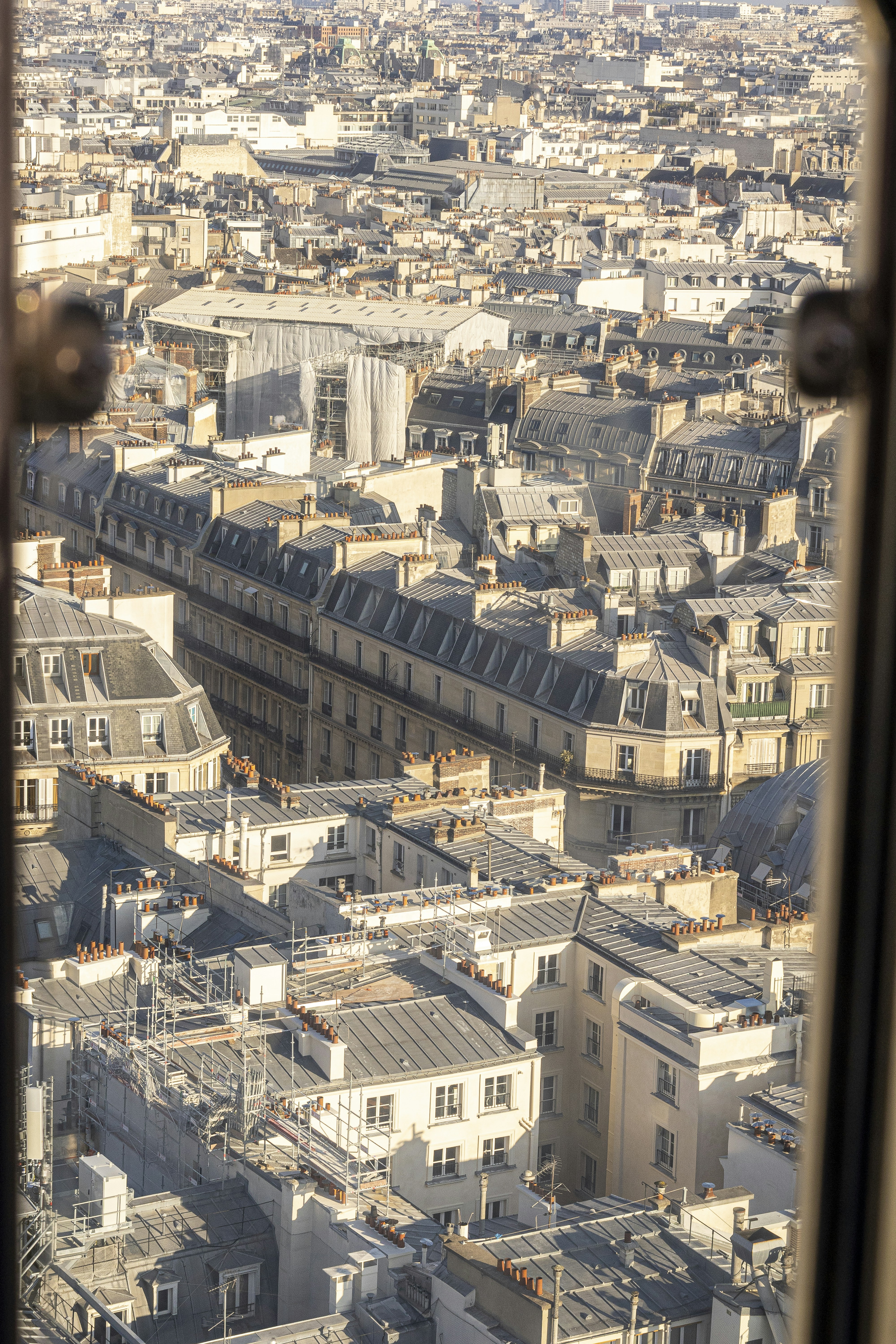 City of Terraced Rooftops from a Narrow Window