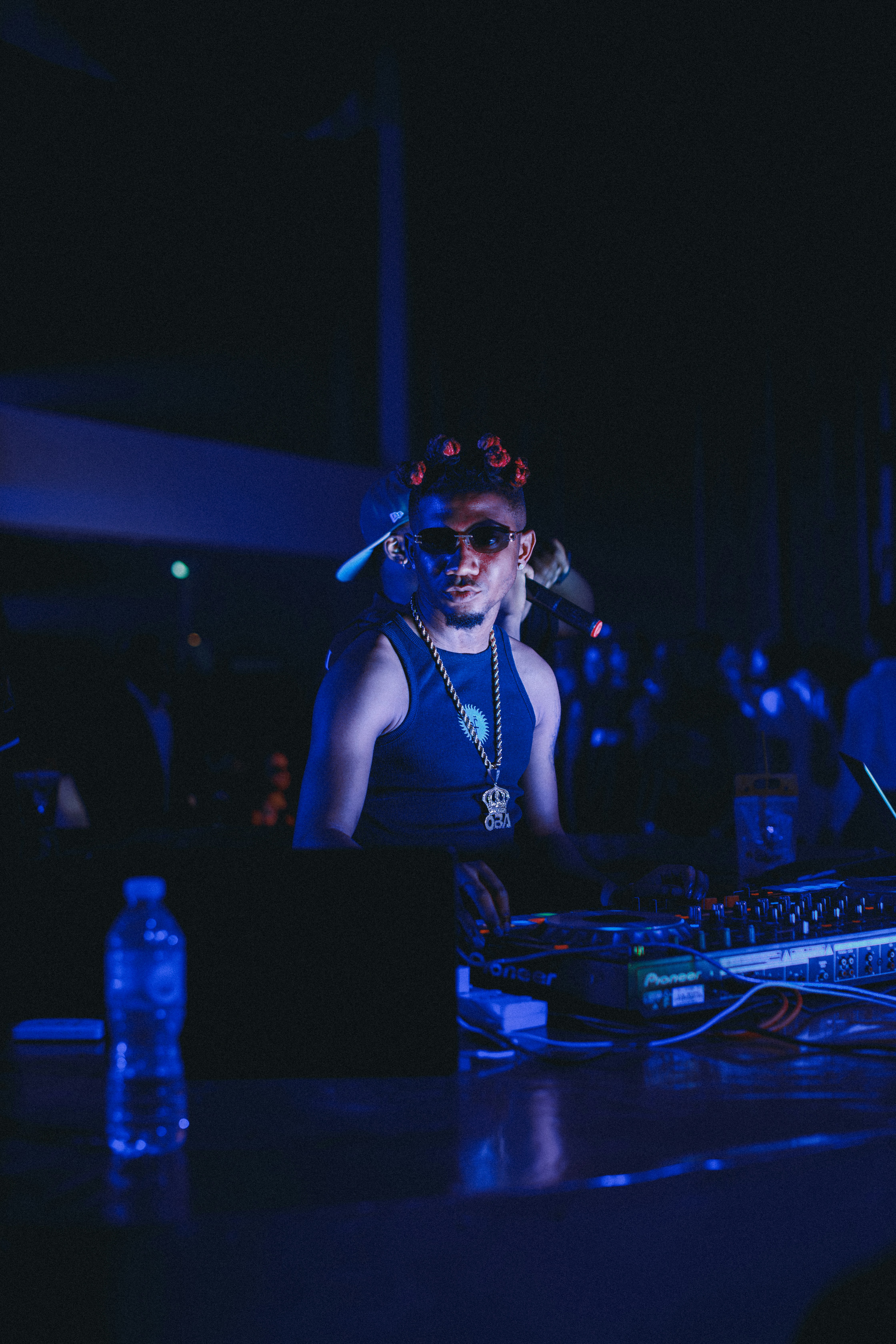 Midnight Pulse: DJ in cobalt glow commands the console