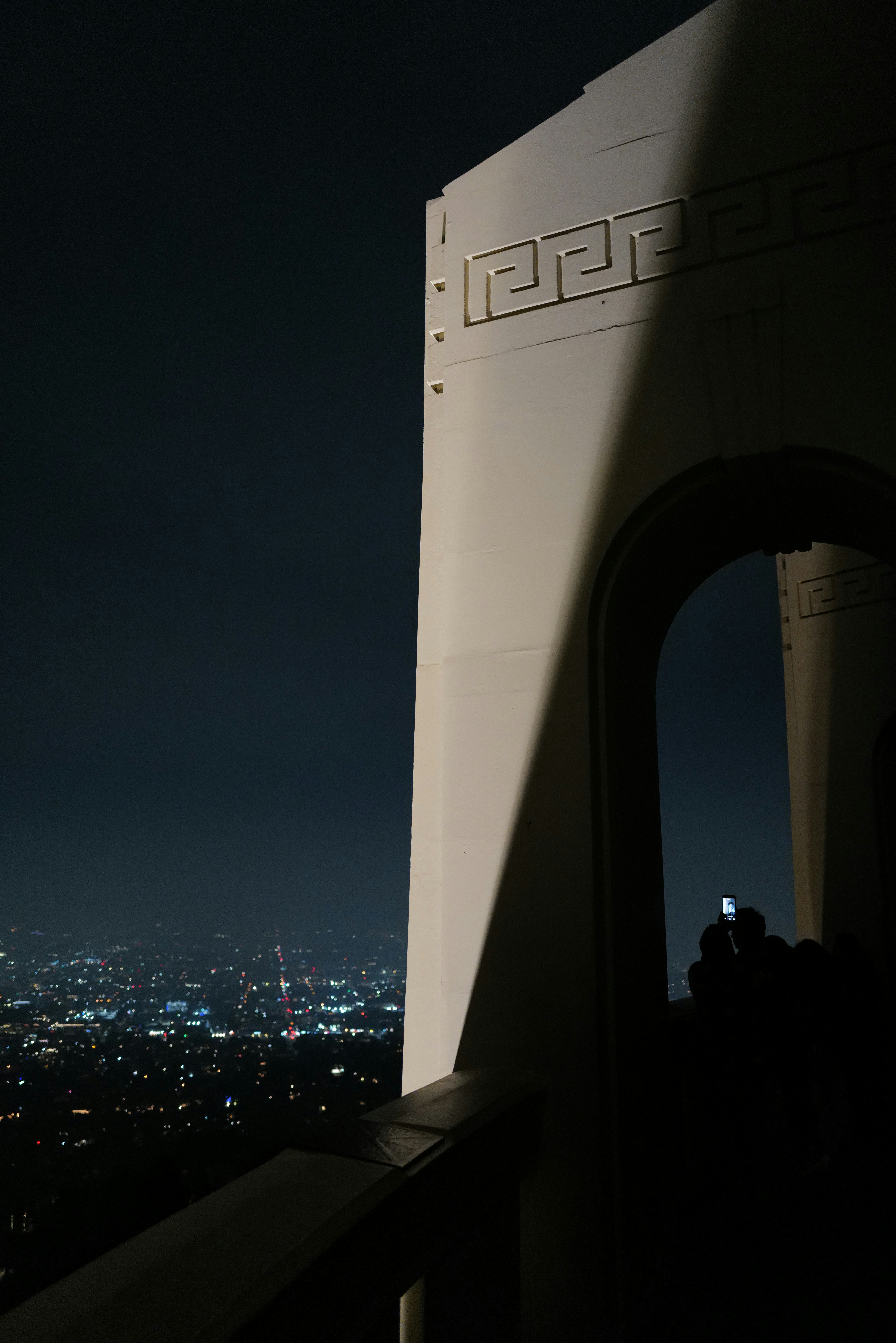 Night at the Arch: City Lights Beyond a Monumental Shadow
