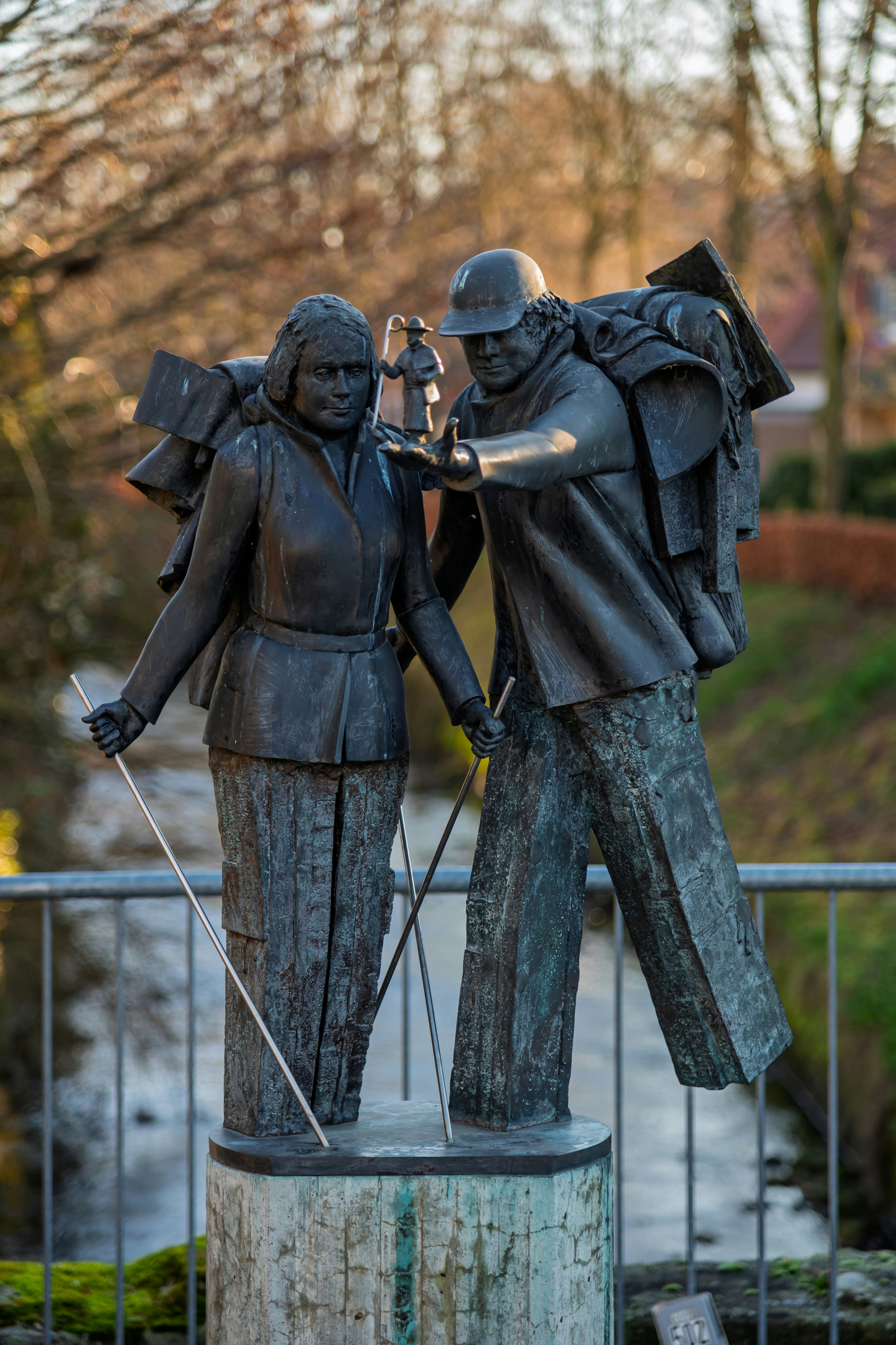 Arms Intertwined: A Duel of Shadows on a Riverfront Plinth