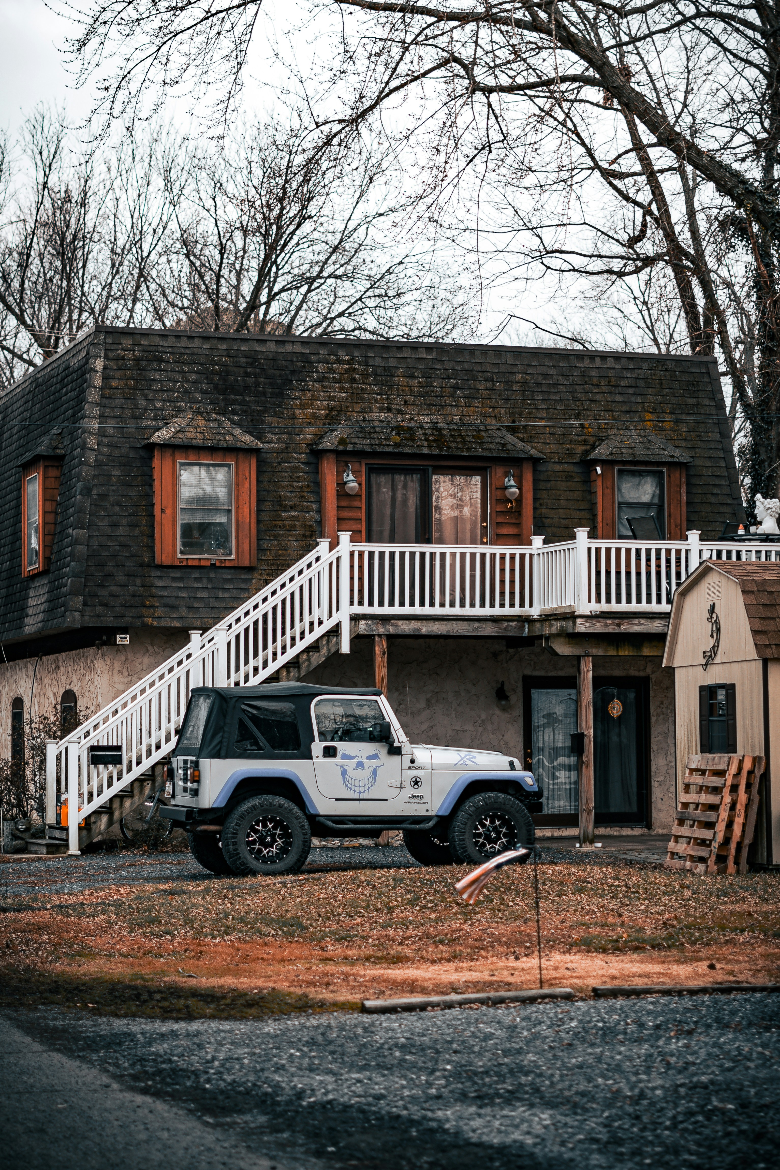 Jeep by the House: Quiet Street Scene with Stark White Railings