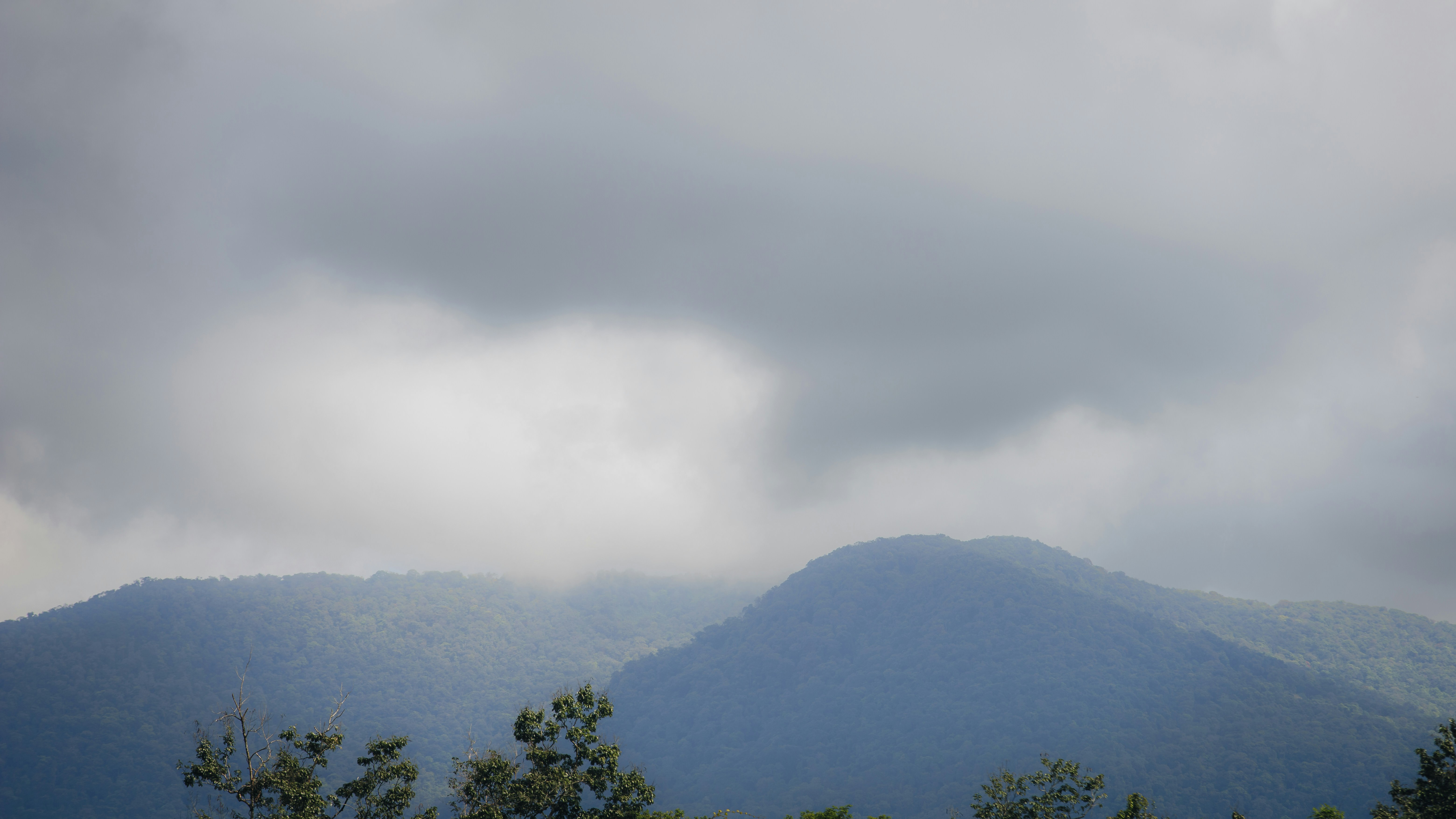 Mist-Softened Ridge: Clouded Mountains Over a Quiet Valley