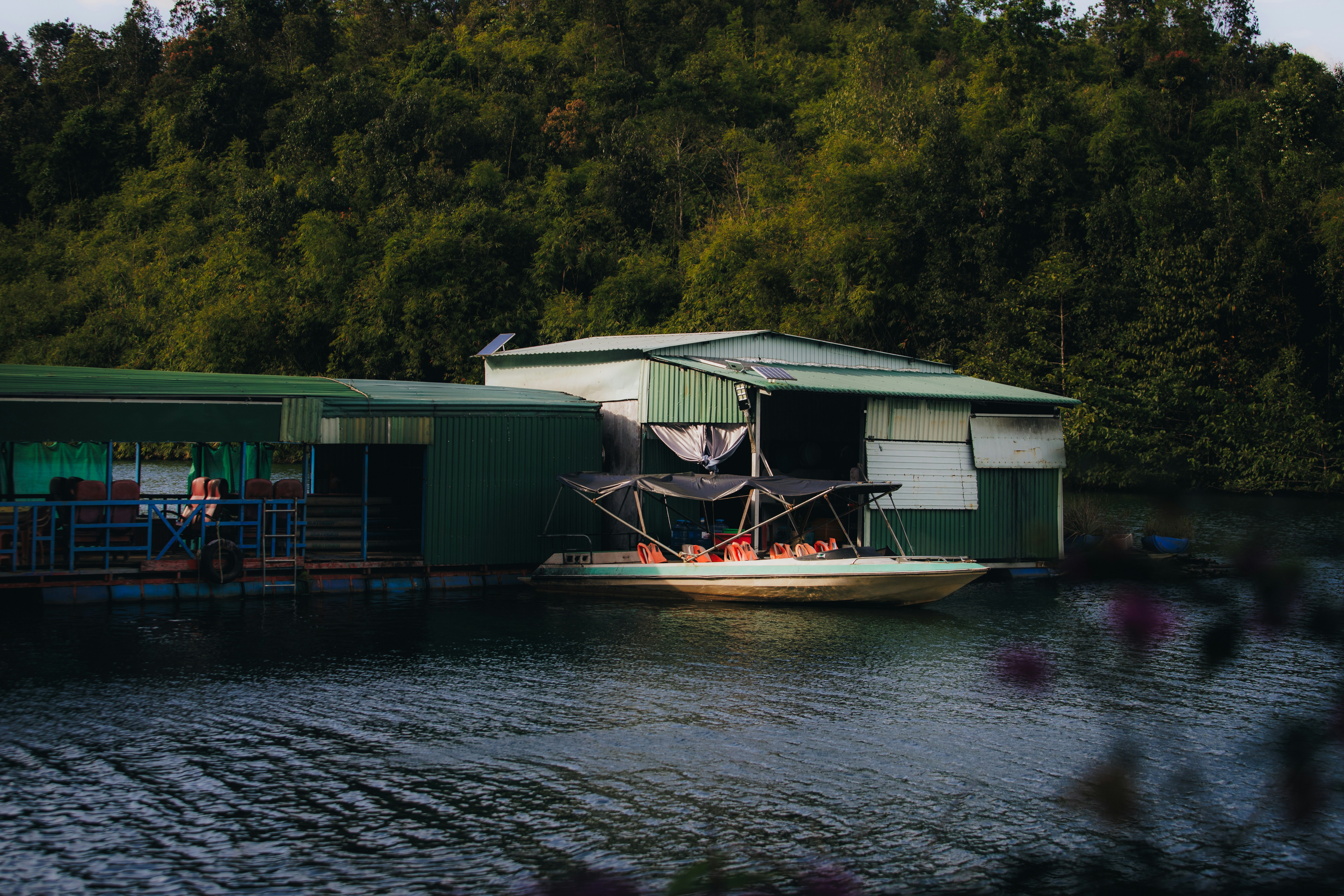 Motorboat Docked at a Green-Wedged Floating Compound