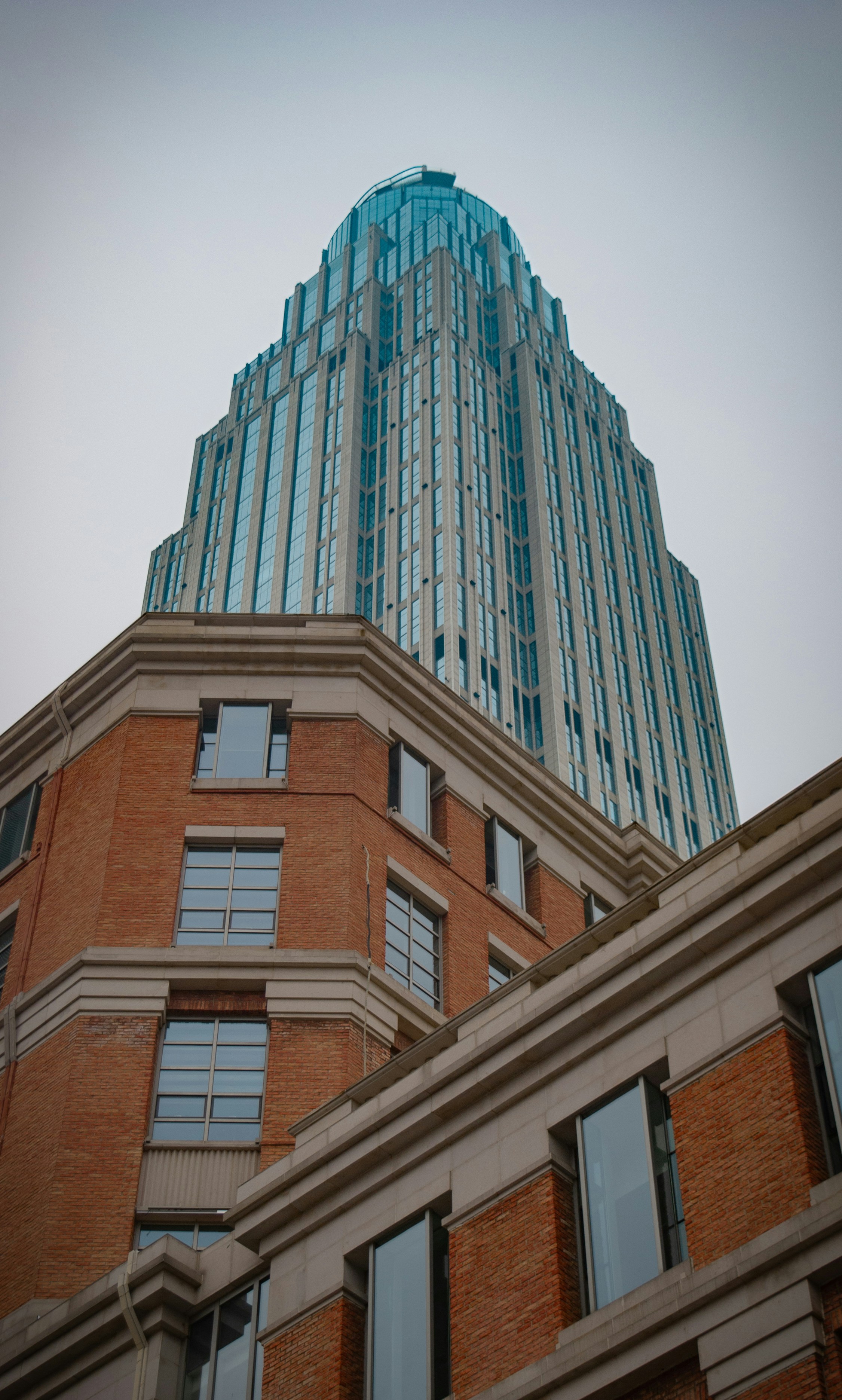 Skyward Facade: A Convergence of Brick and Glass Rising Essence