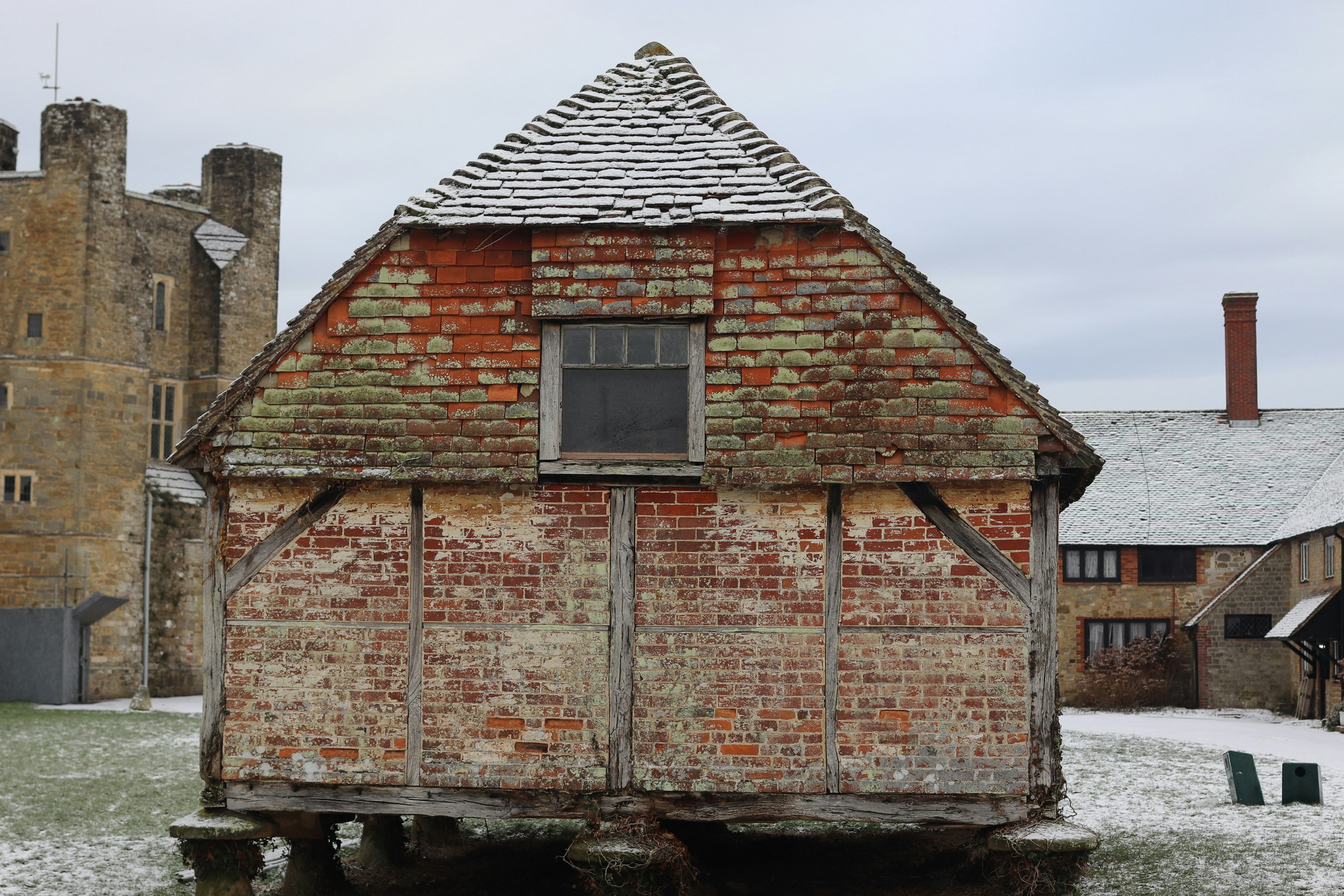 Brick and Timber Cottage on Stilts by a Historic Castle